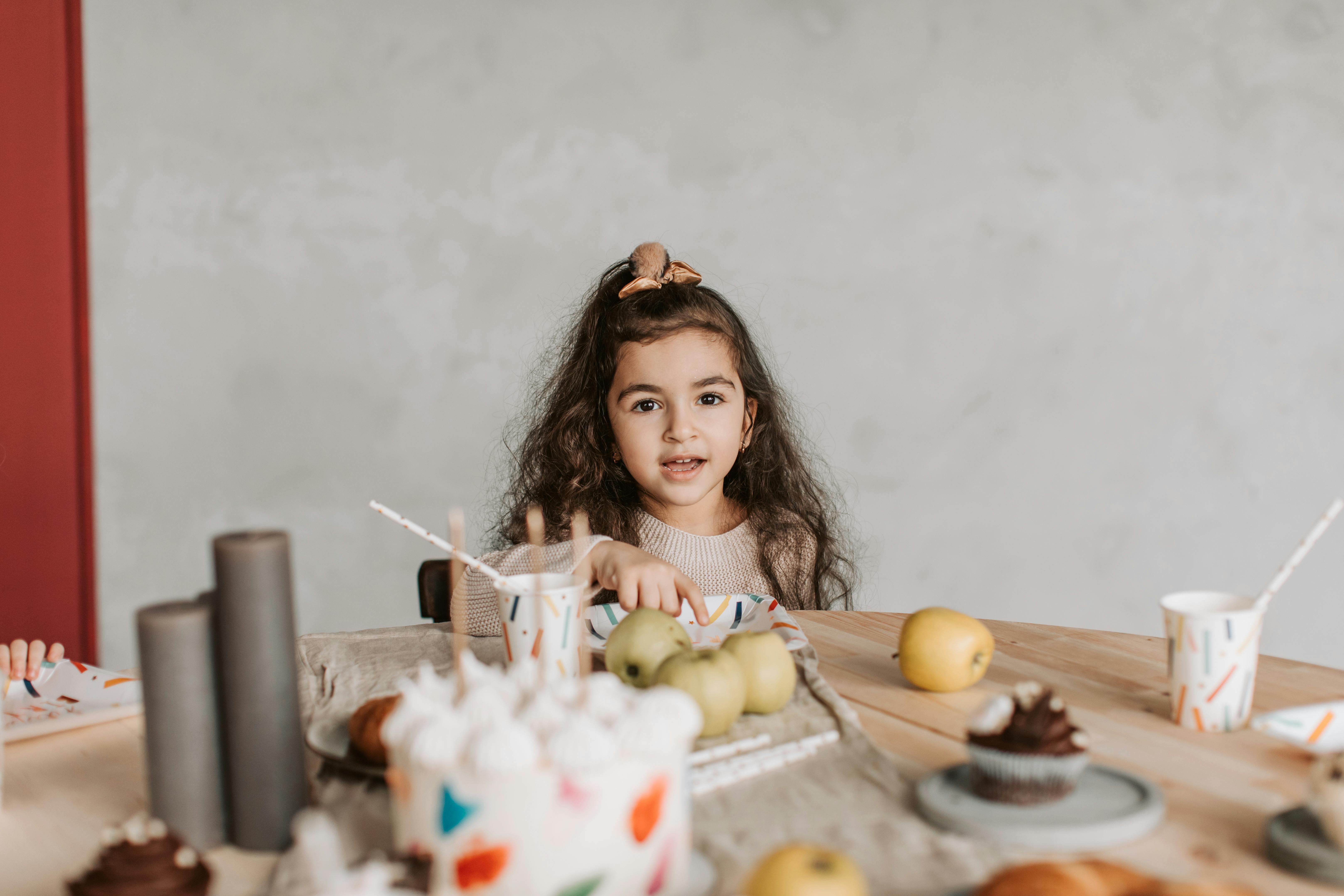 Brunette Girl Sitting at Table with Birthday Cake · Free Stock Photo