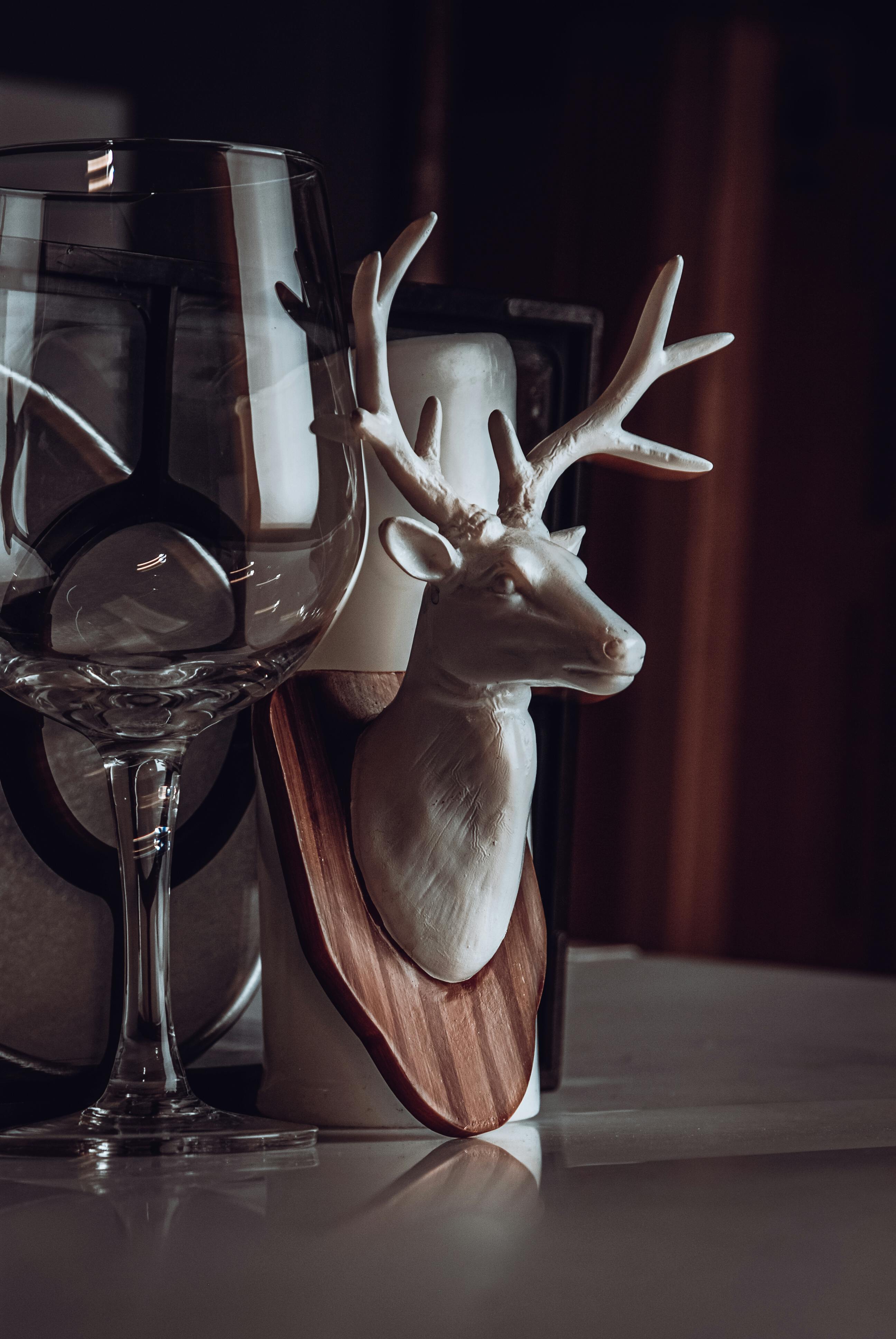 Glass near Buck Statue · Free Stock Photo