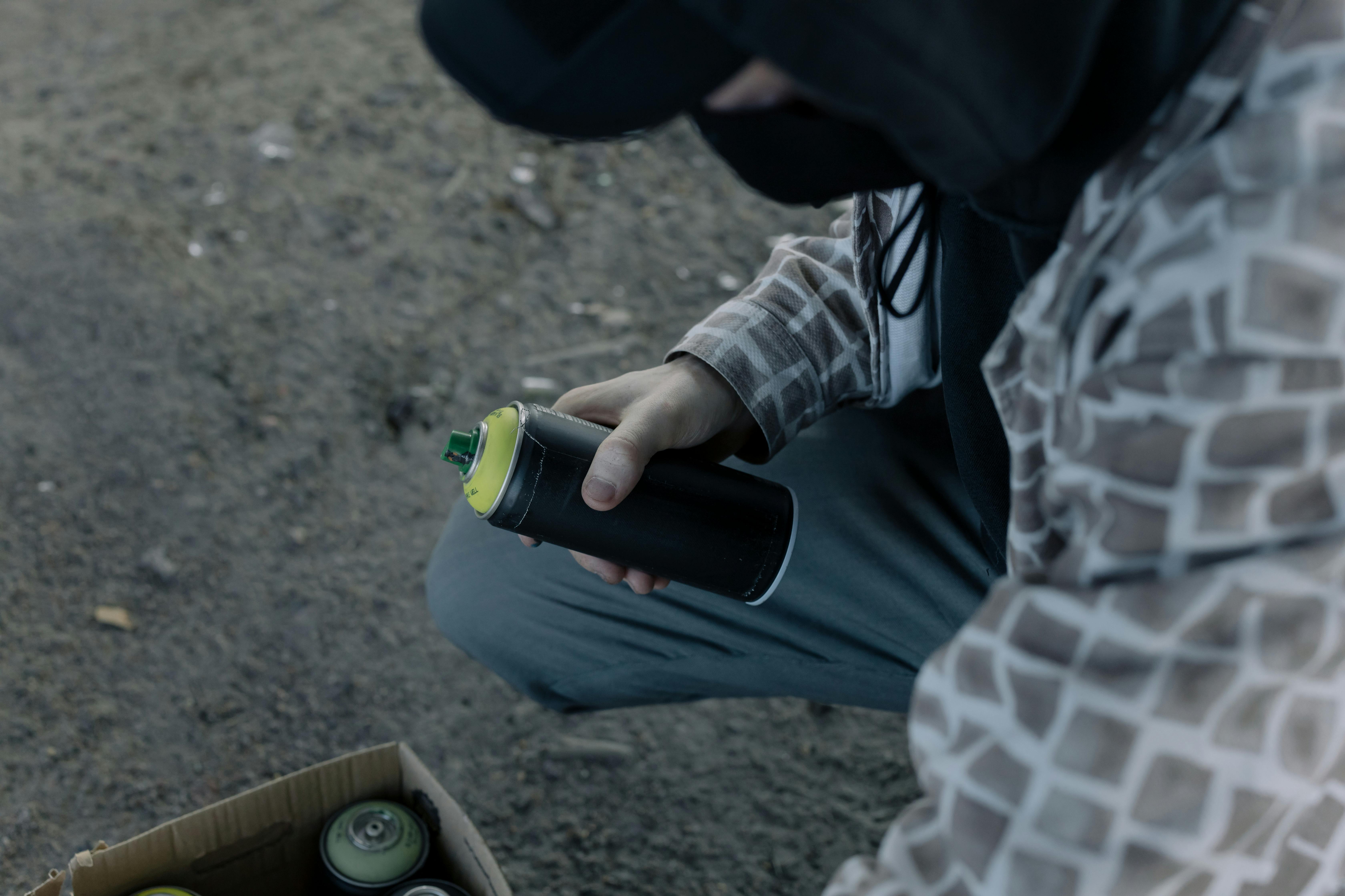 Person Holding Black Spray Bottle · Free Stock Photo