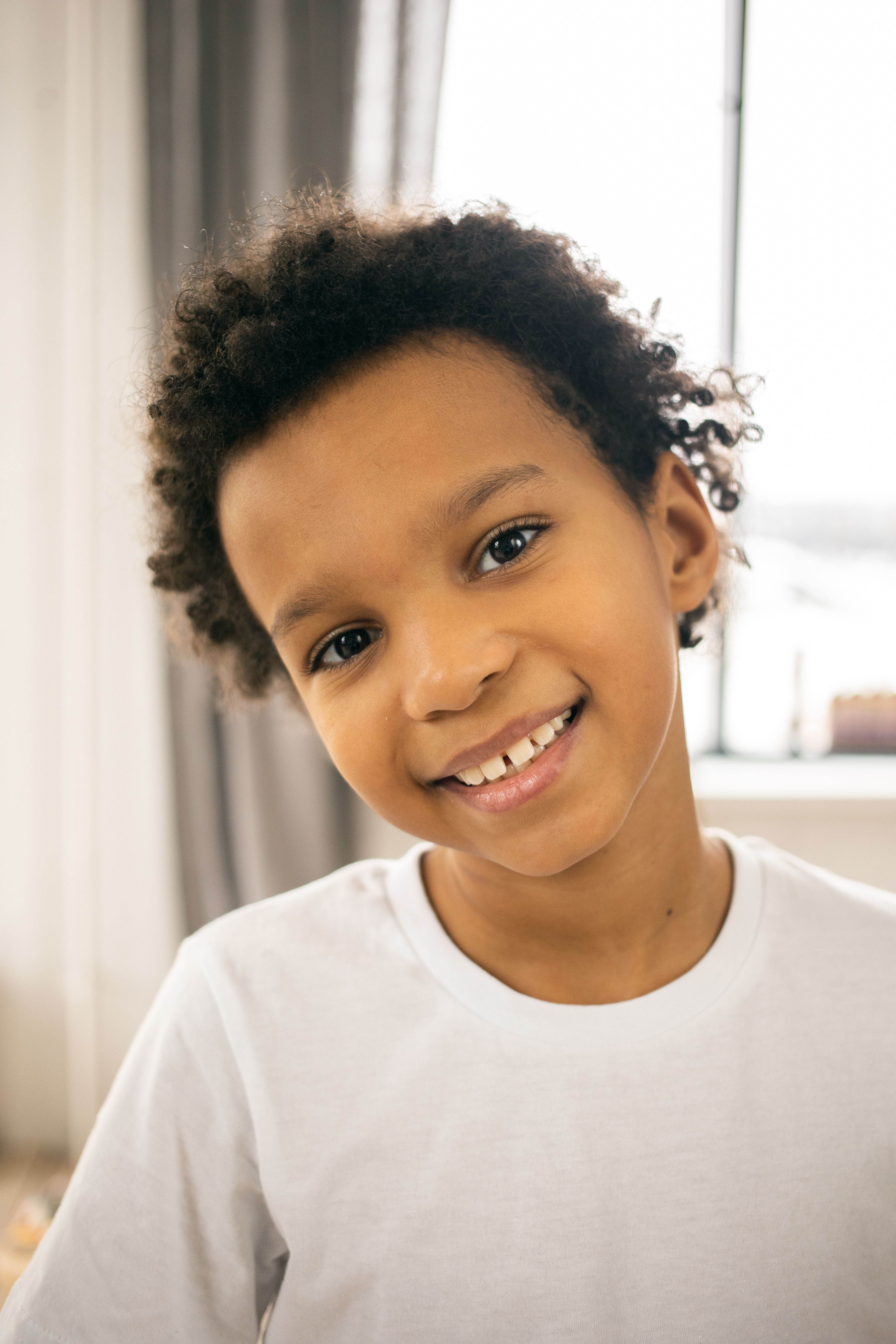 Black boy with potted plant in hands · Free Stock Photo