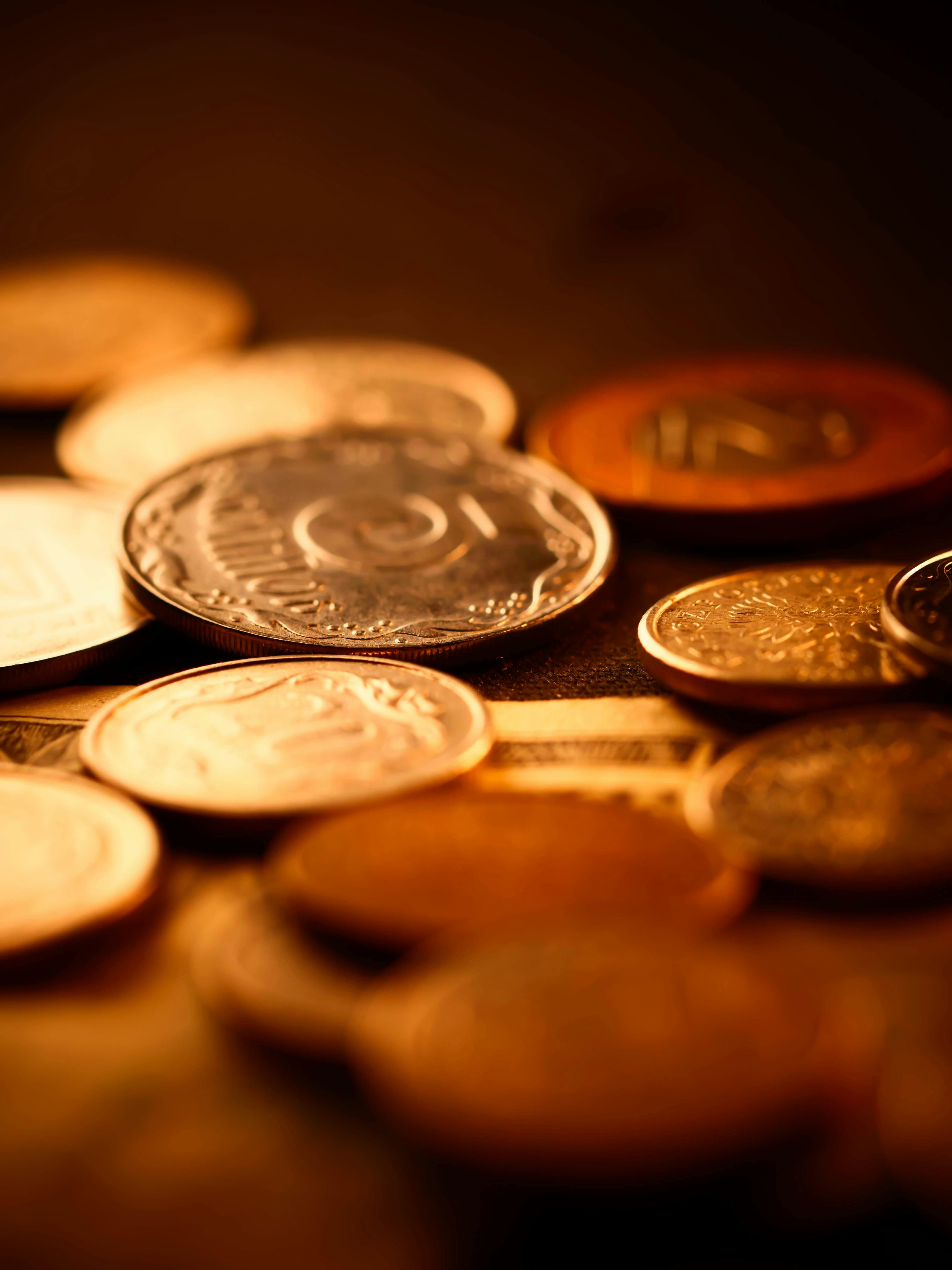 Close-Up Shot of Coins and Bills · Free Stock Photo
