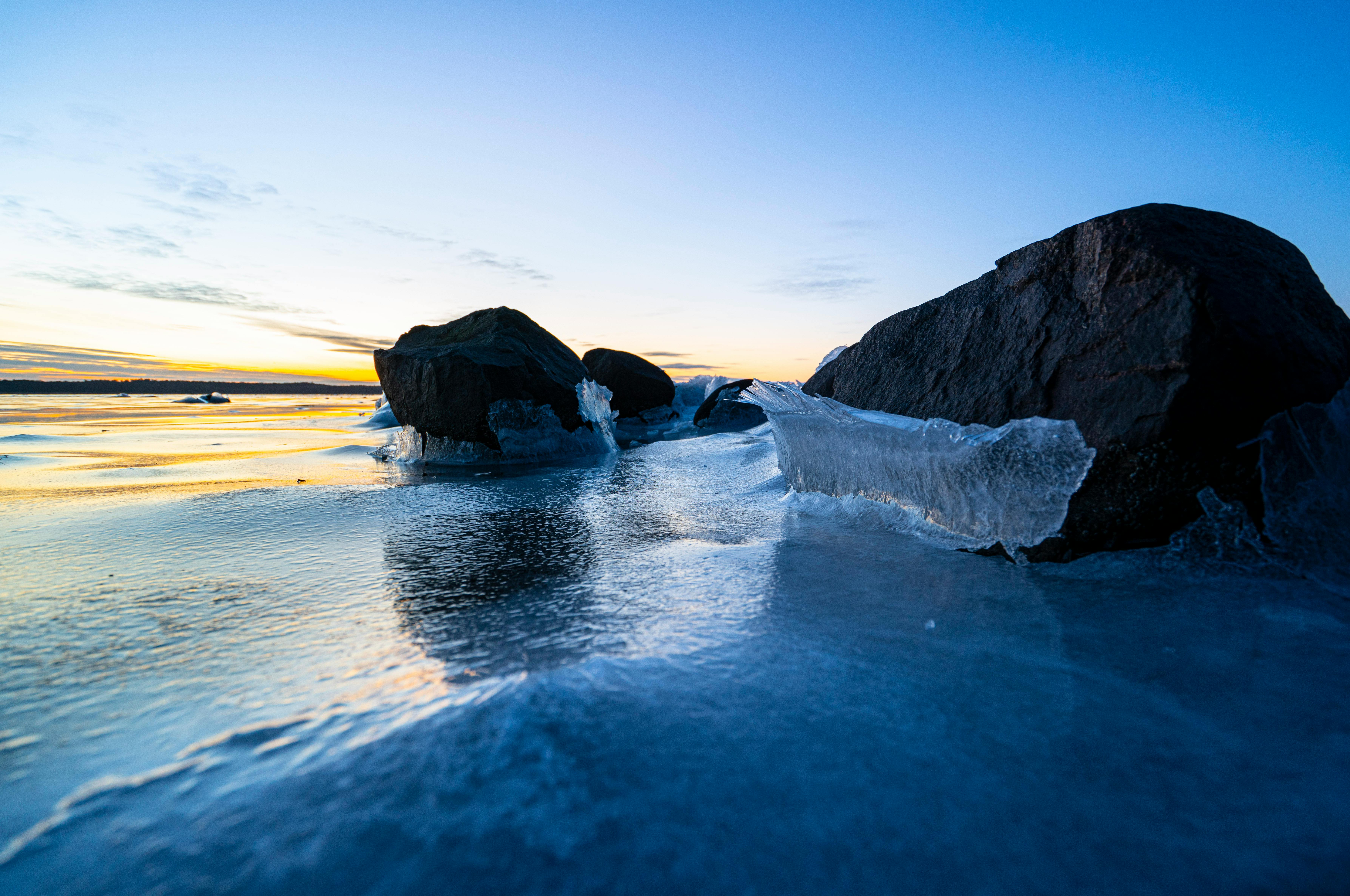 Beach, Rock Formations and Ice Blocks at Sunset · Free Stock Photo