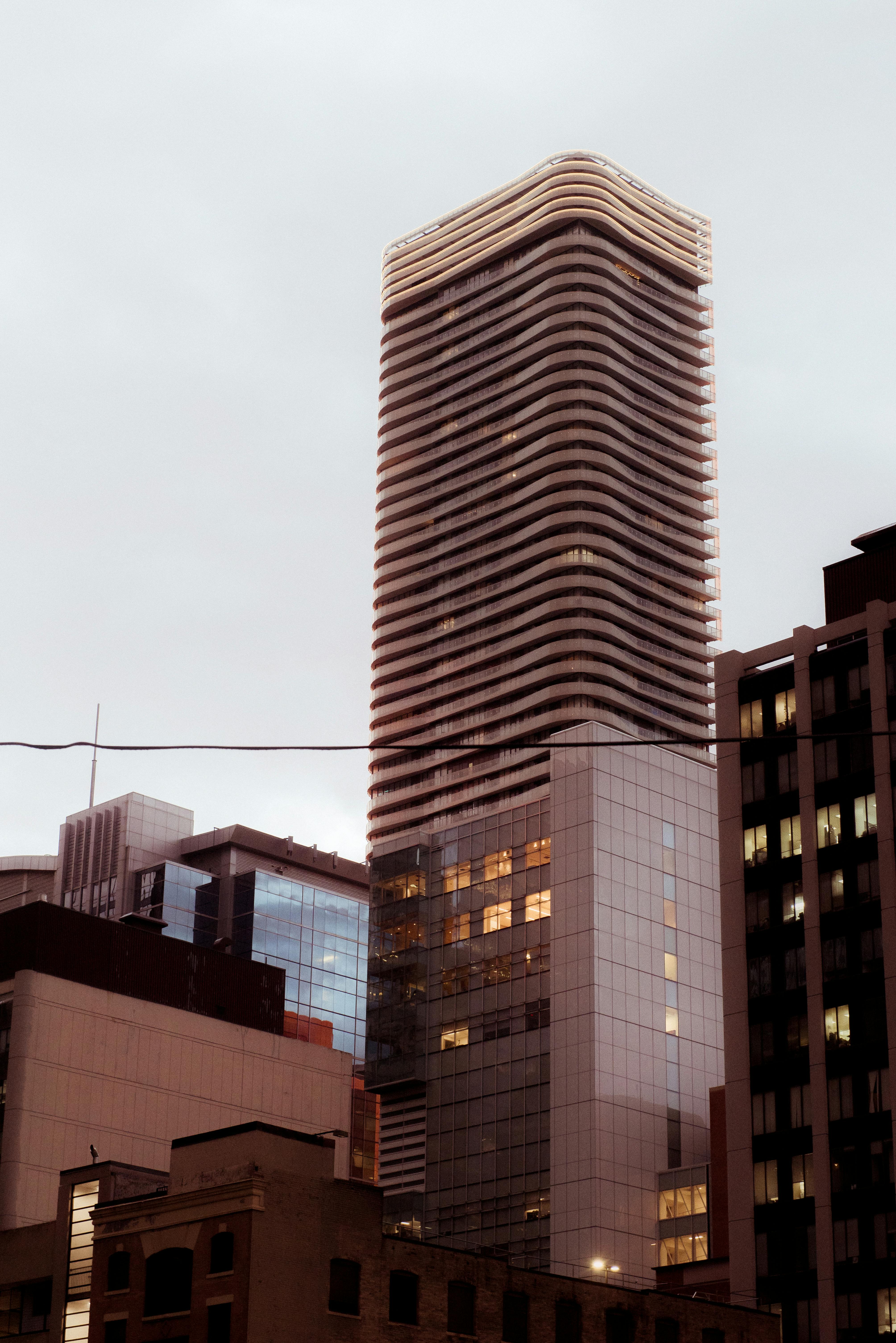 Modern skyscraper against cloudless sky · Free Stock Photo