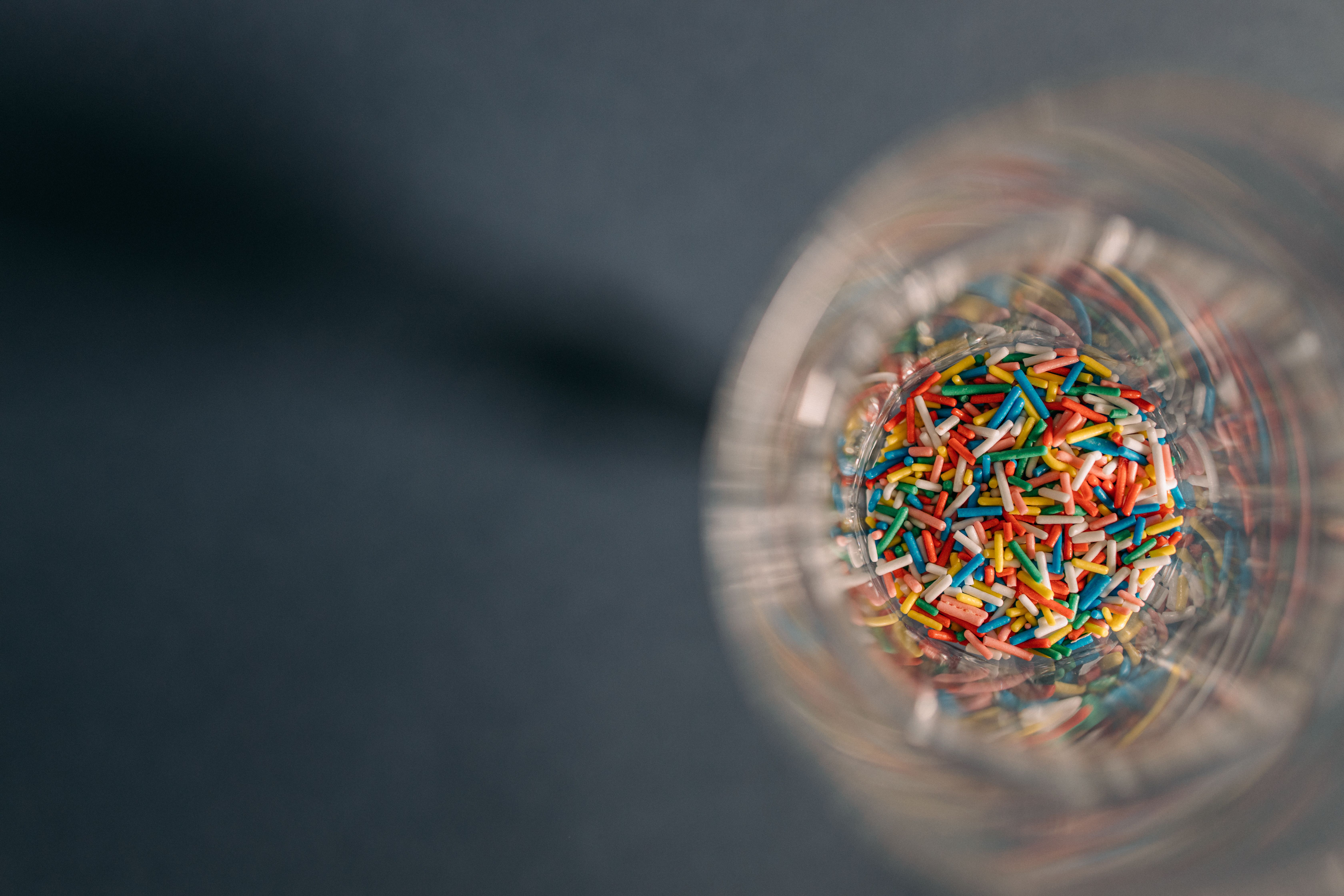 Colorful Sprinkles Spilling from a Glass · Free Stock Photo