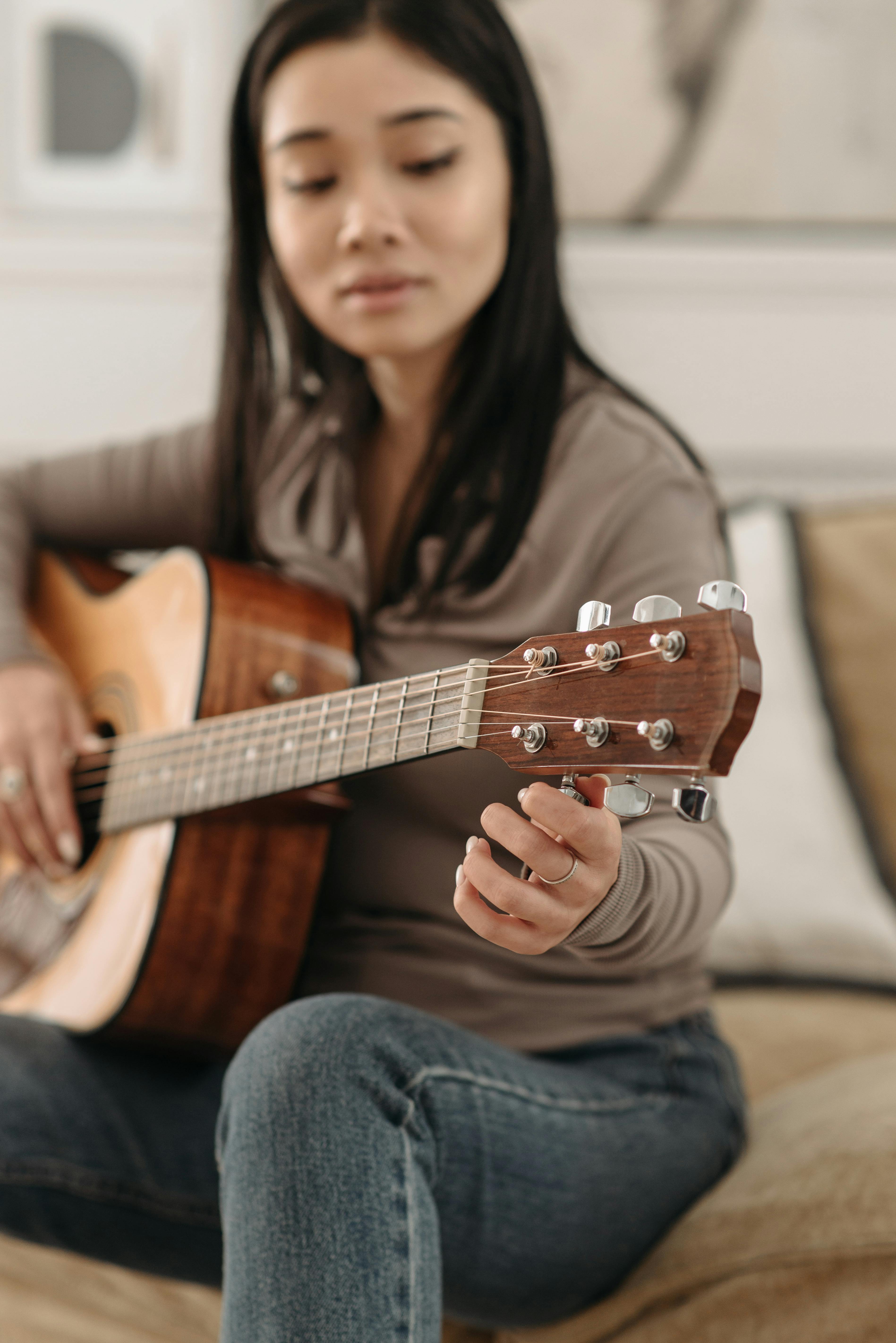 Person Holding an Acoustic Guitar · Free Stock Photo