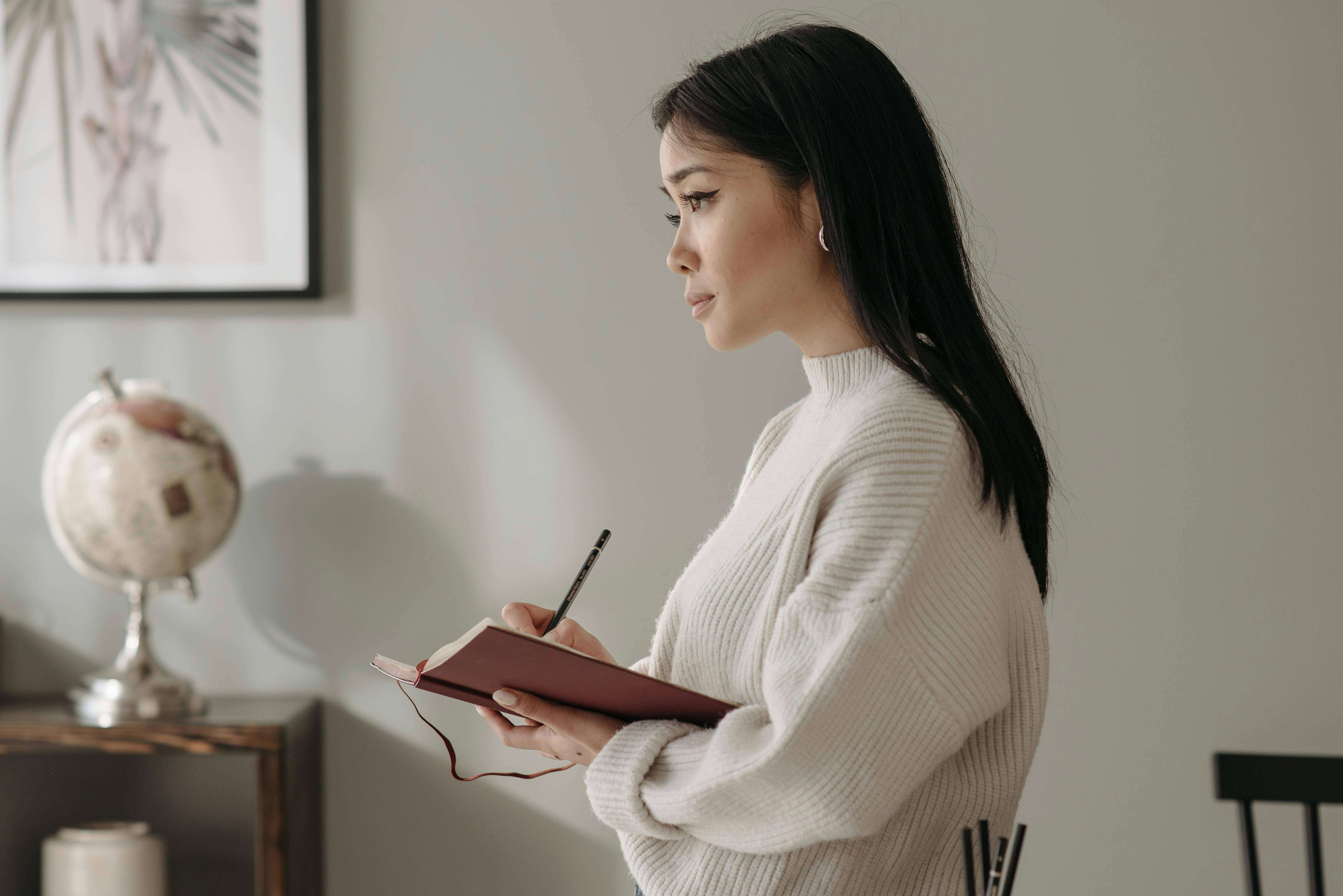 A Woman Holding a Notebook · Free Stock Photo