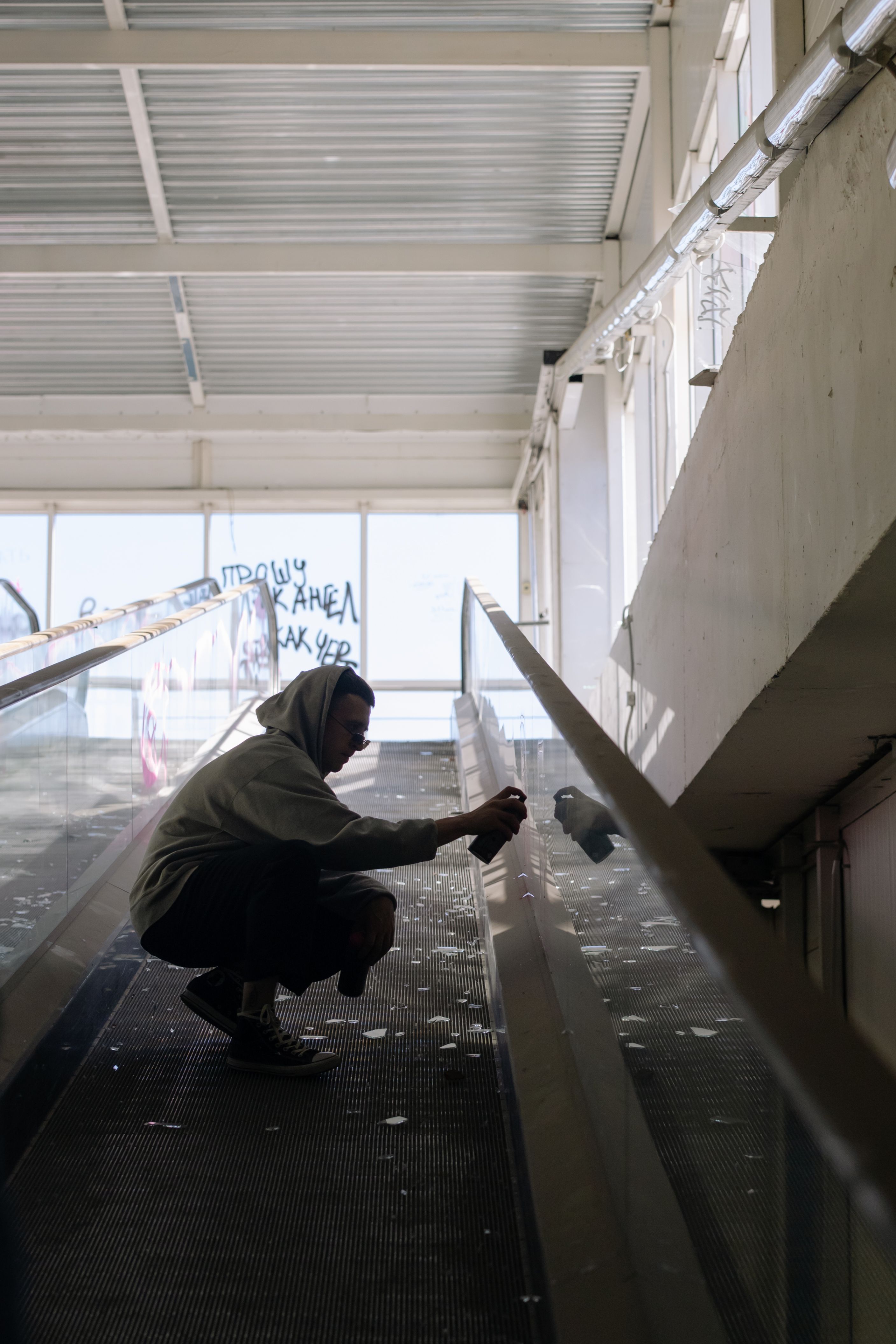 A Man Doing Vandalism on the Walkalator Glass · Free Stock Photo