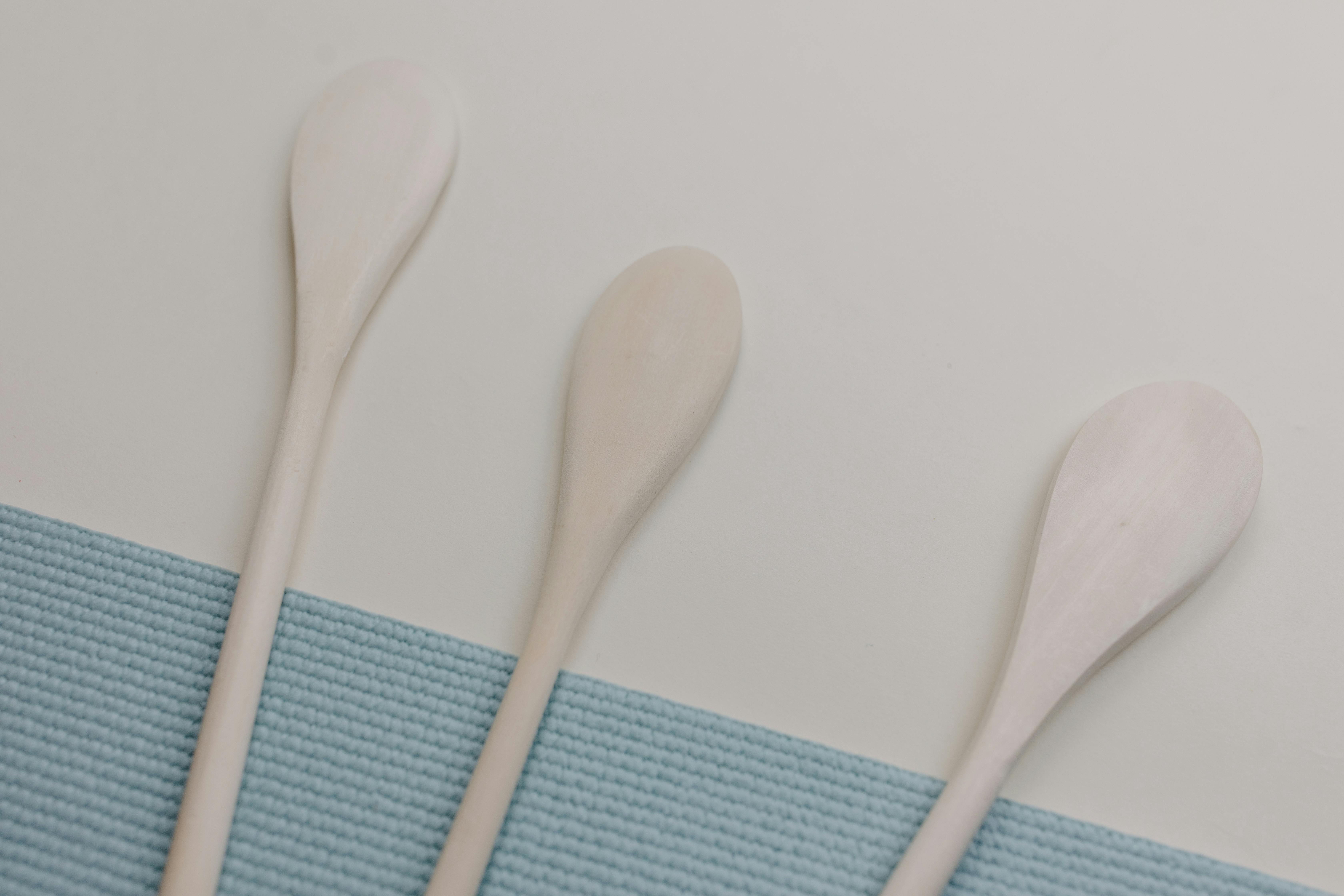 Top View of Light Wooden Kitchen Spoons Lying on a Blue Cloth · Free ...