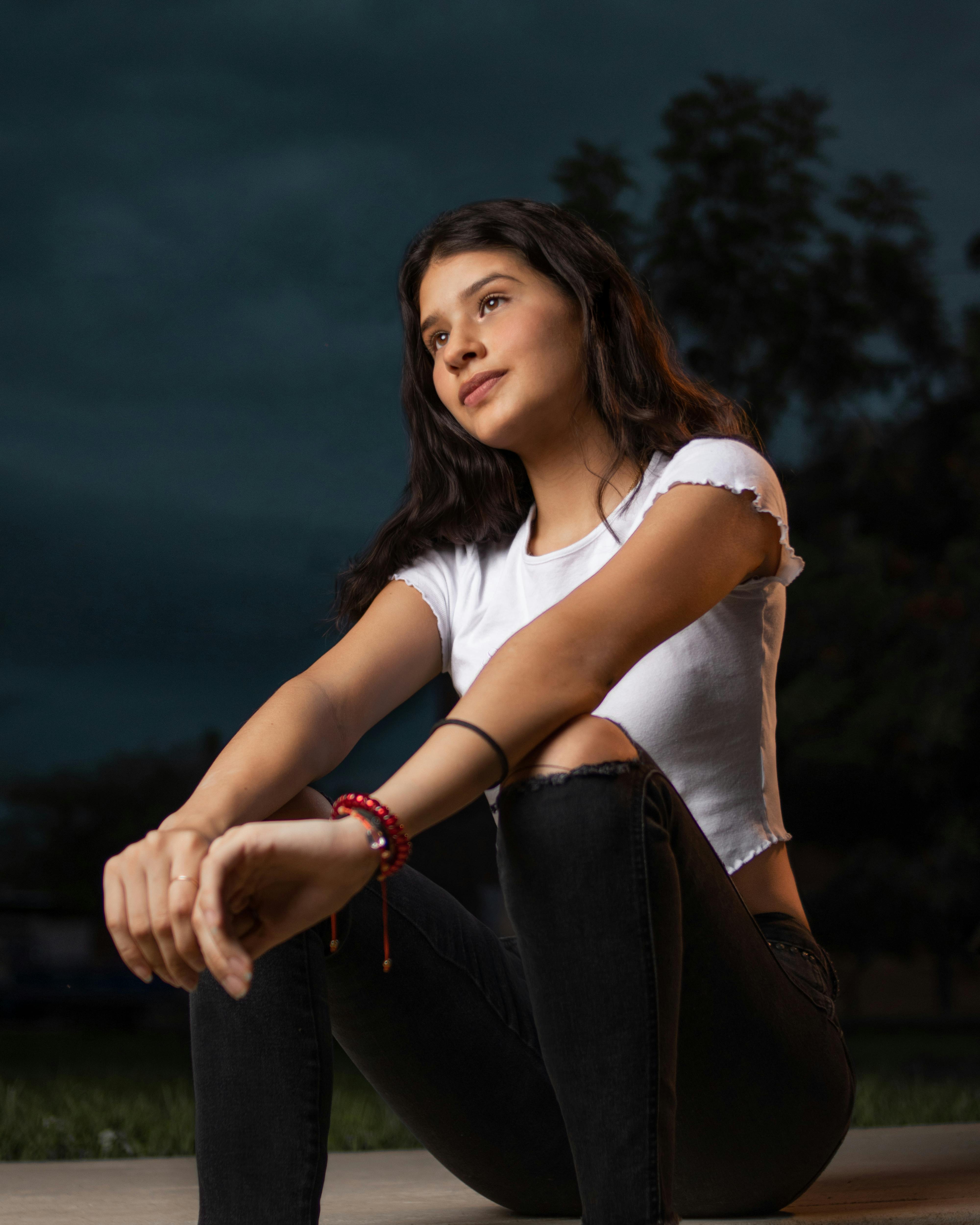 Photograph of a Girl in a White Shirt Sitting · Free Stock Photo