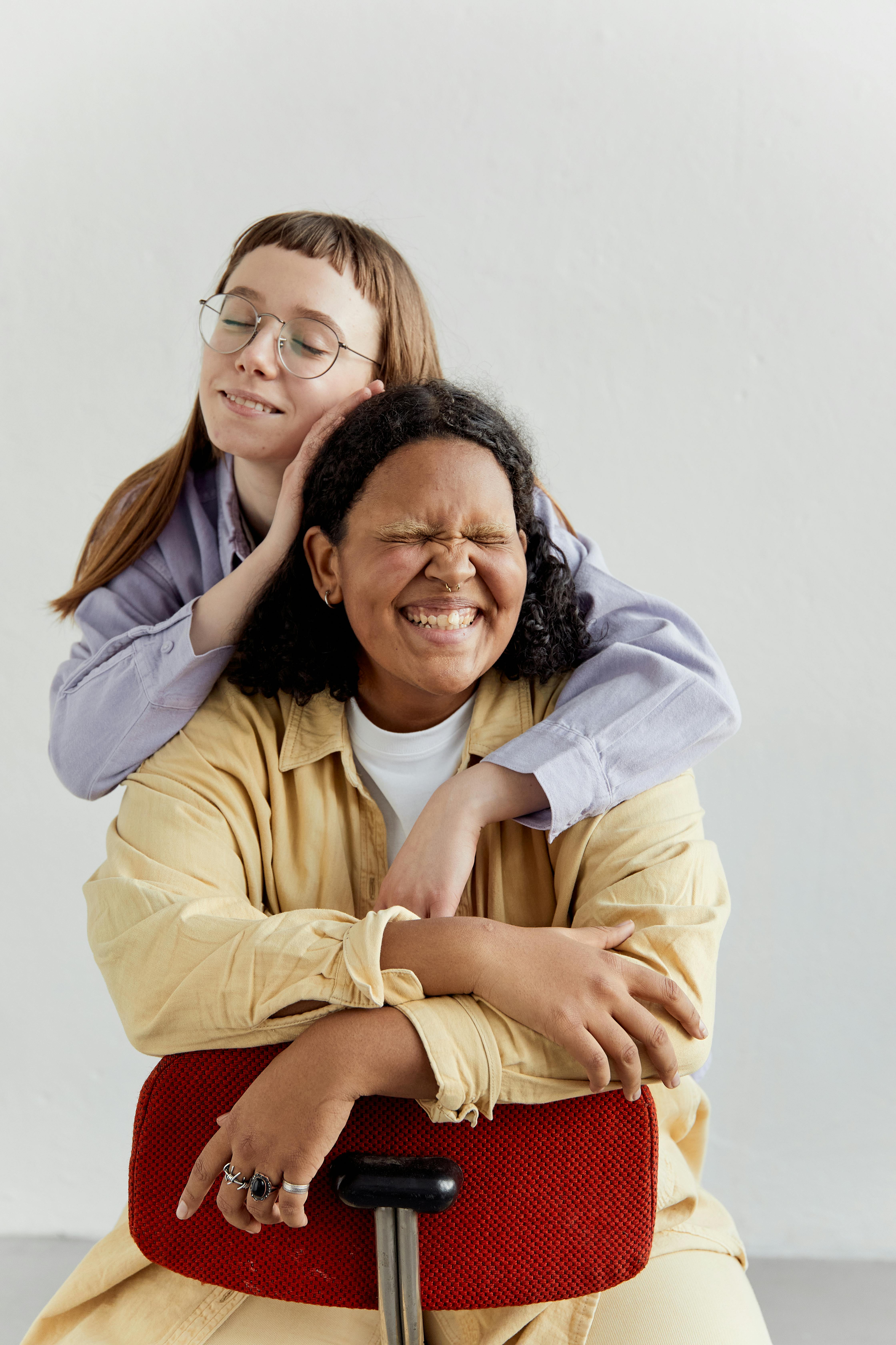 Photo of Girls Posing Back to Back · Free Stock Photo