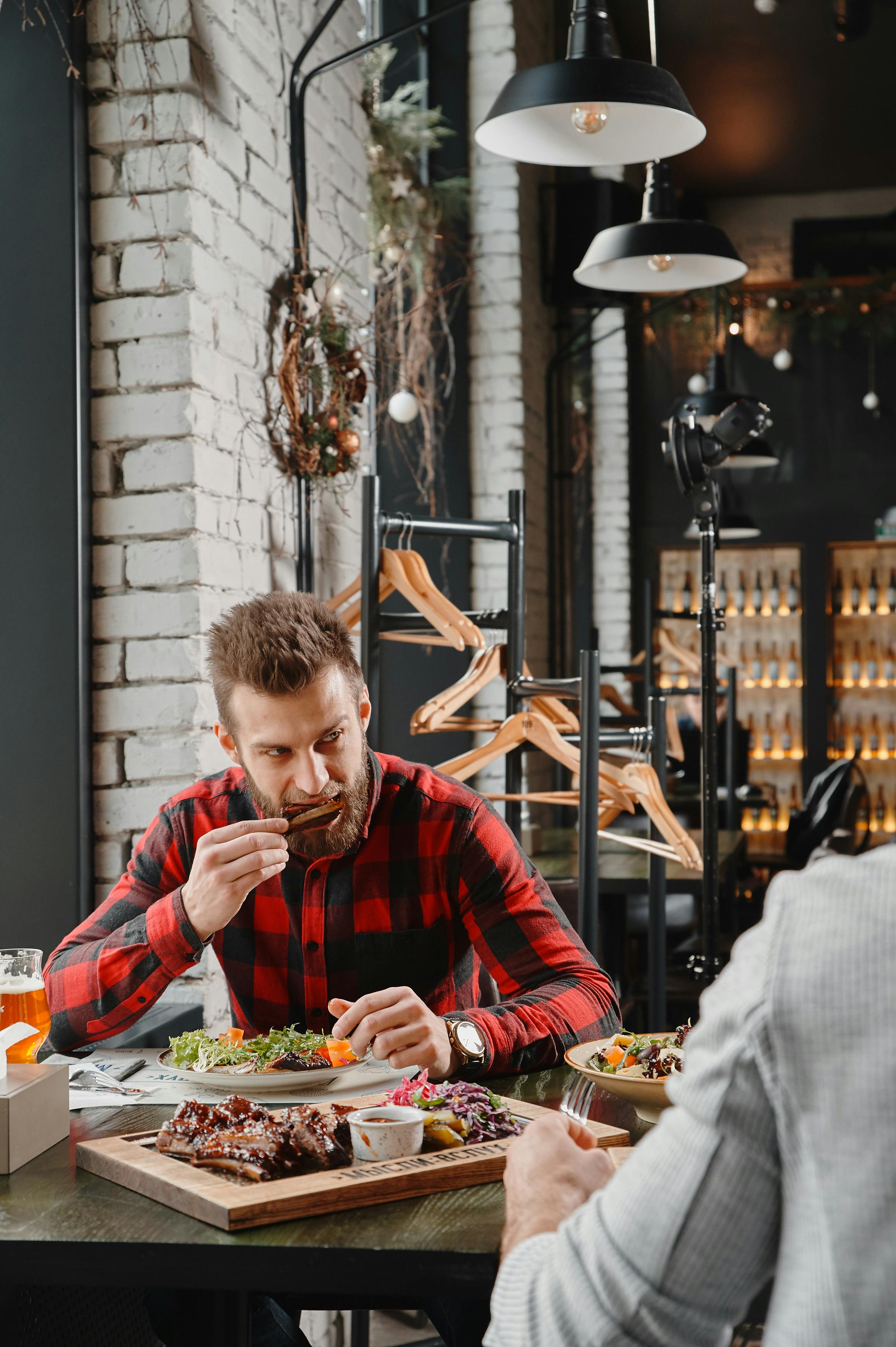 Photo of a Man Eating Ribs · Free Stock Photo