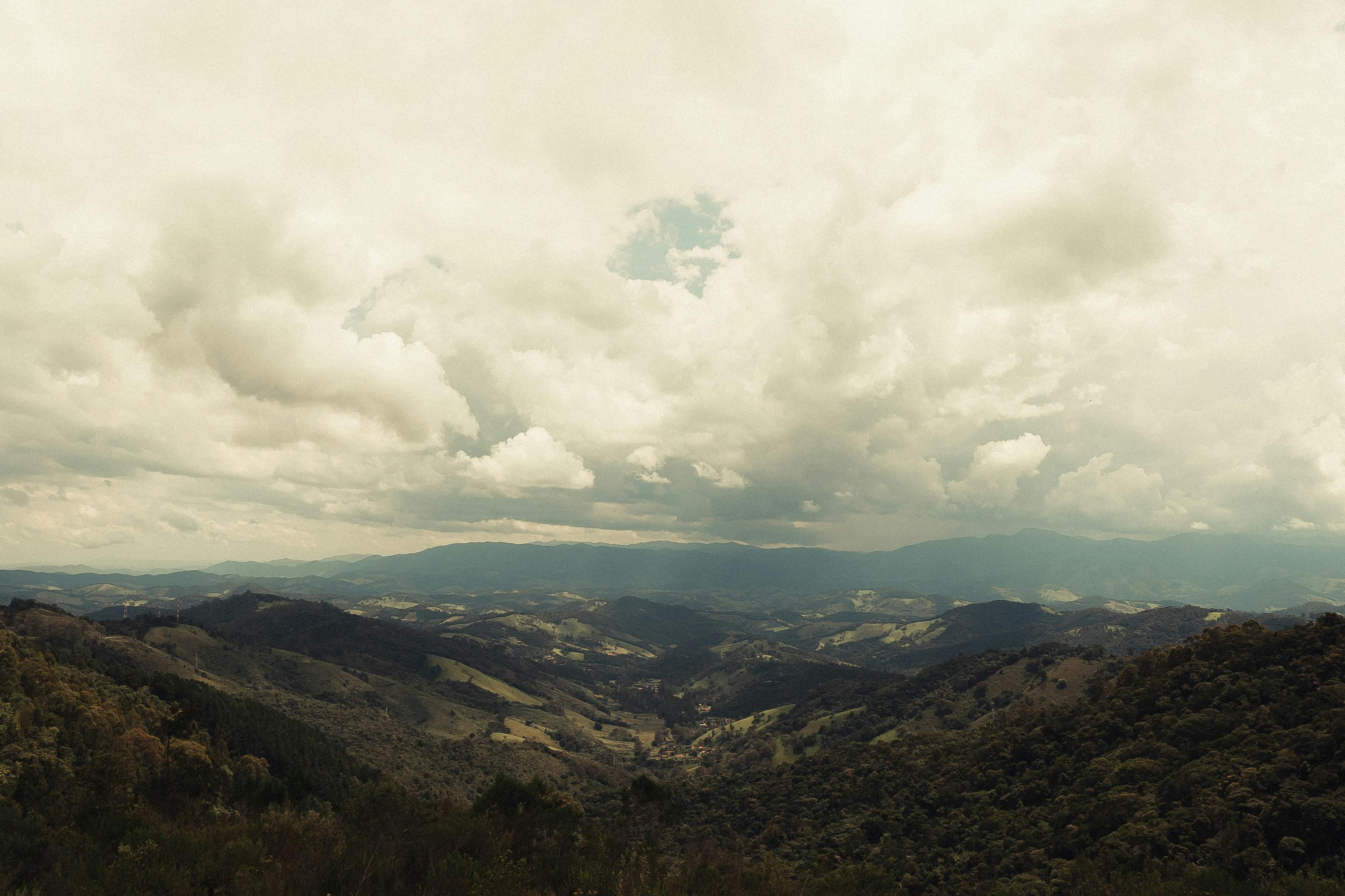 Green rocky cliff near blue lake · Free Stock Photo