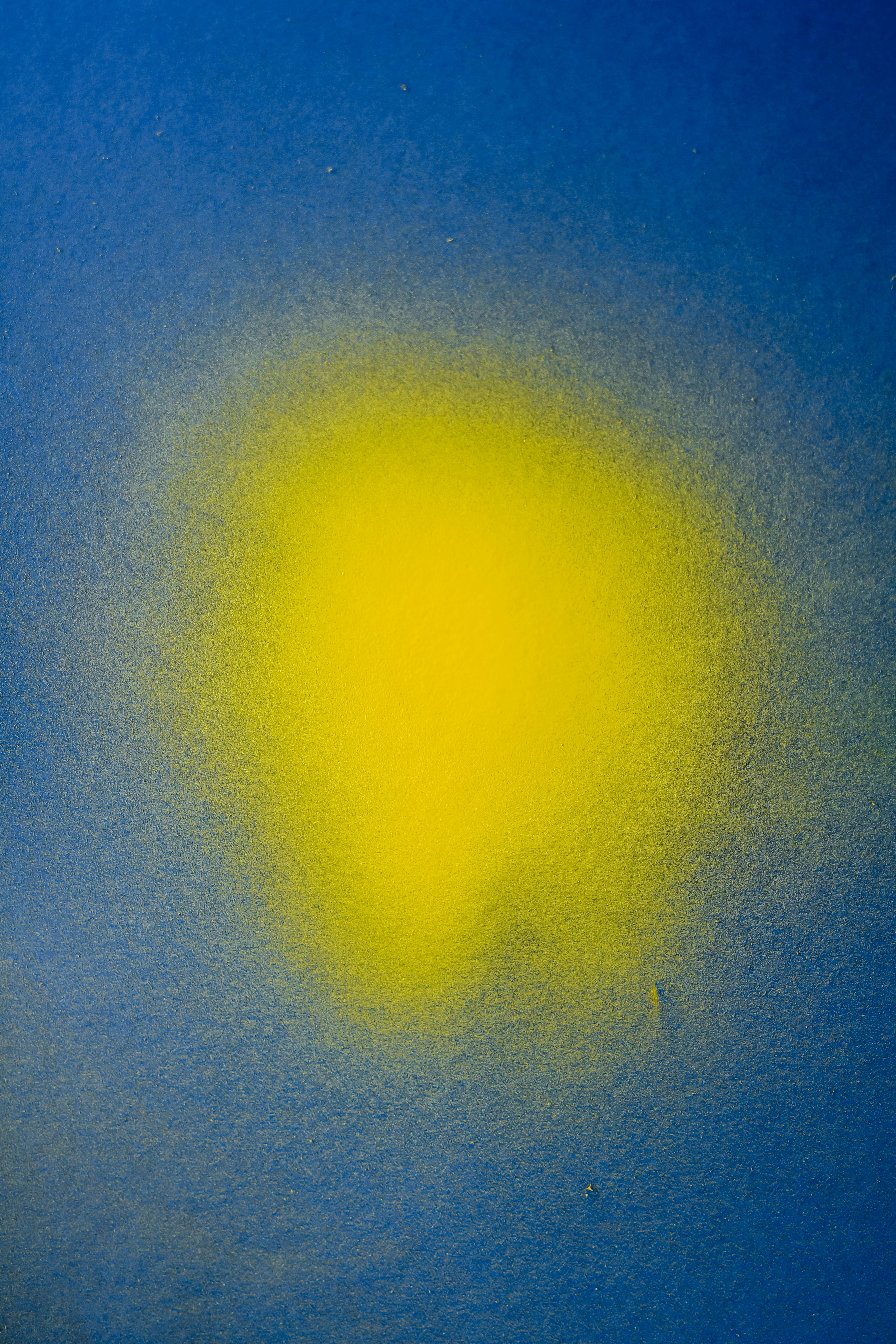 Stain of Yellow Spray Paint on a Blue Wall · Free Stock Photo