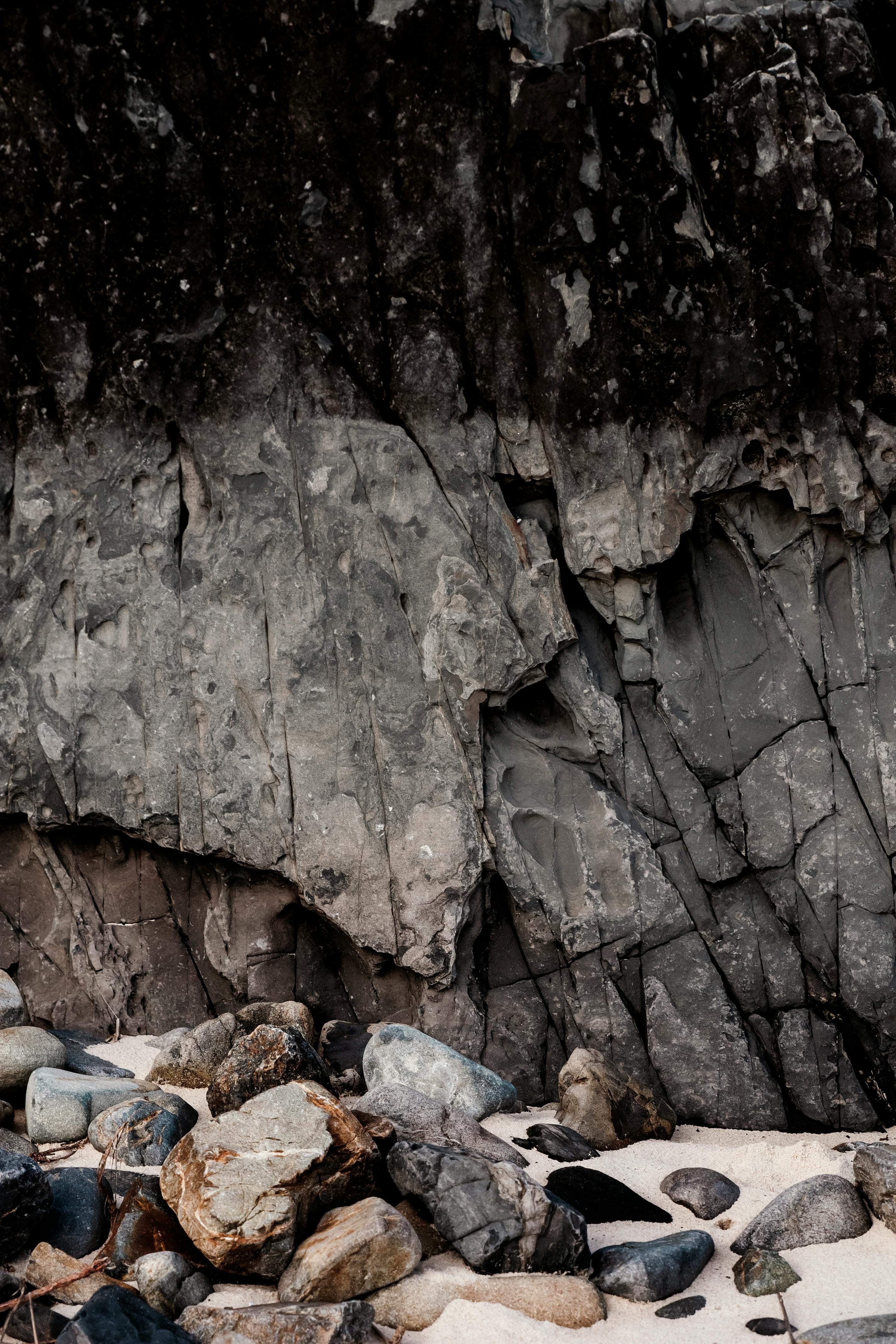 Rock Cliff on Sand Seashore · Free Stock Photo