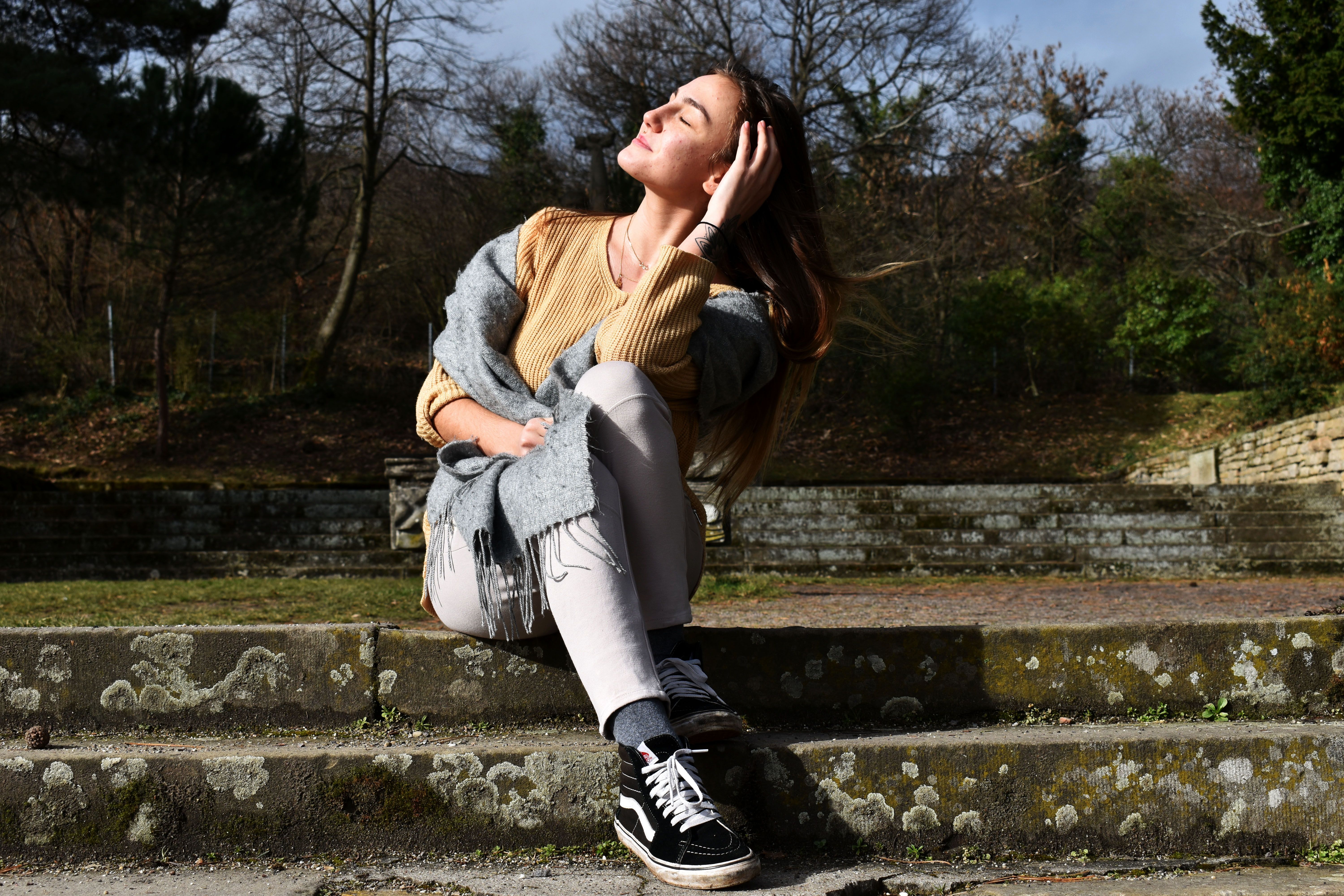 A Woman Posing while Sitting on the Steps · Free Stock Photo