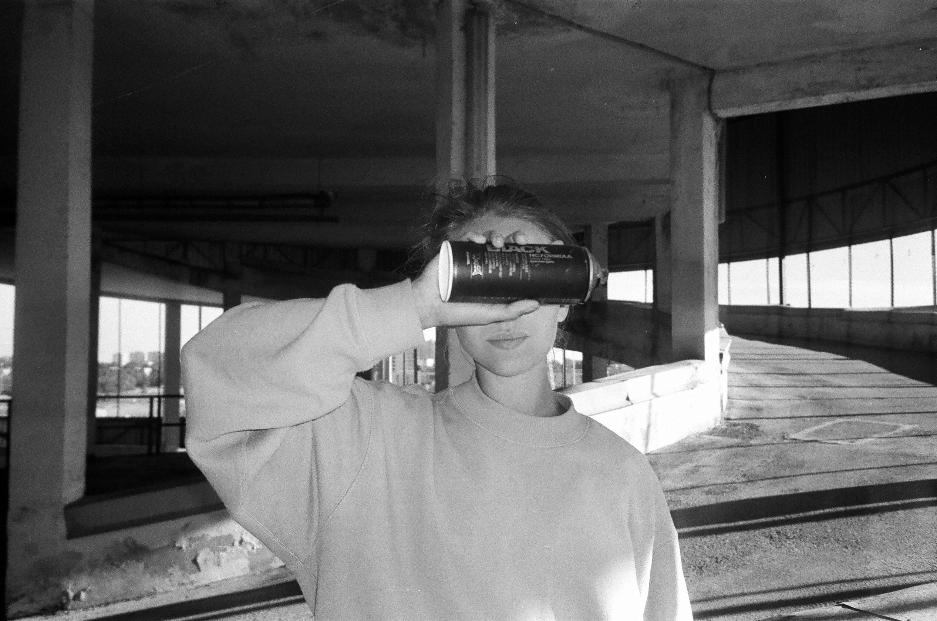 Grayscale Photo of a Woman Holding a Spray Can · Free Stock Photo