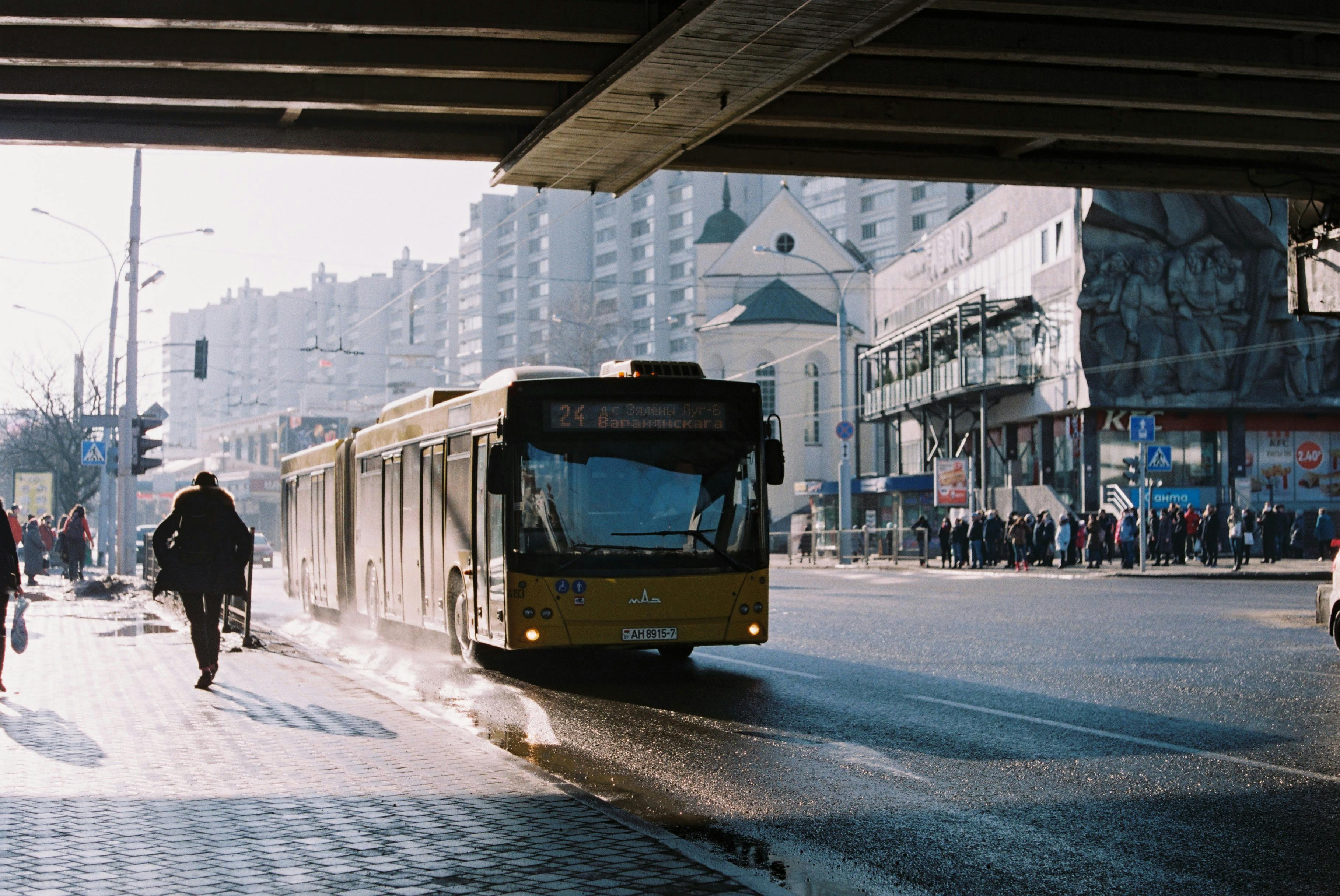 Yellow Bus Stopping Under a Bridge · Free Stock Photo