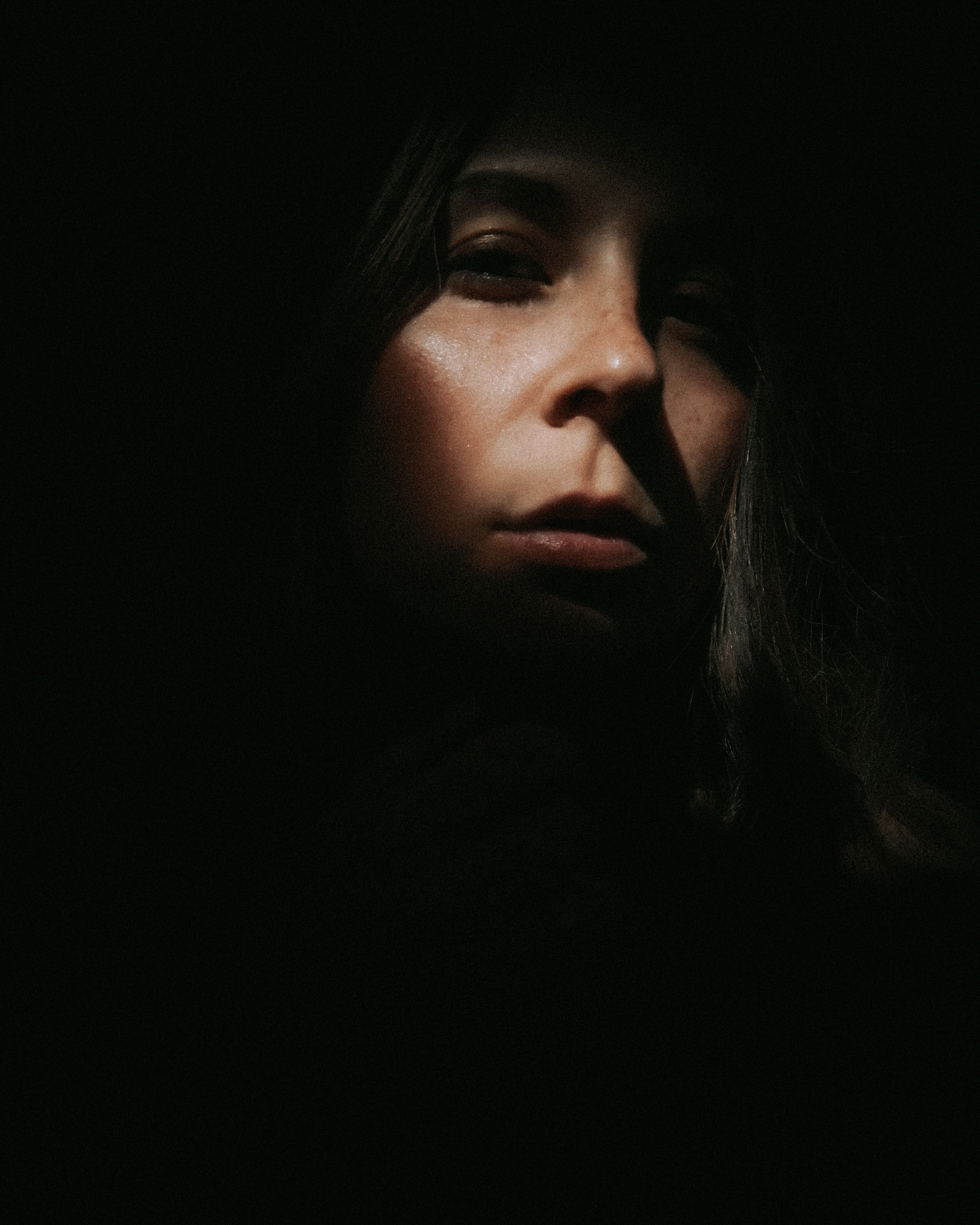 Human face peeping out of darkness · Free Stock Photo