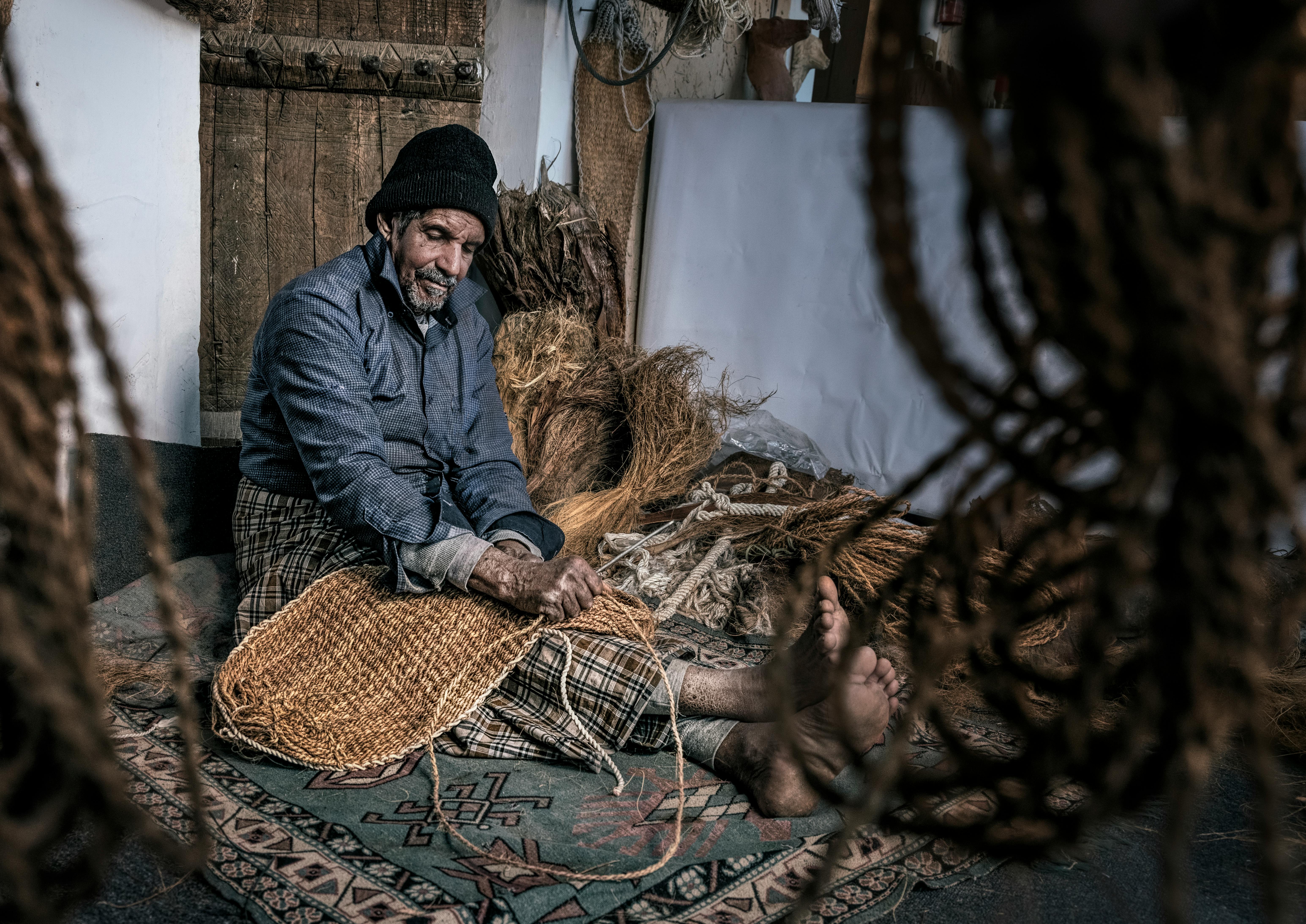 Elderly Man weaving using Straws · Free Stock Photo