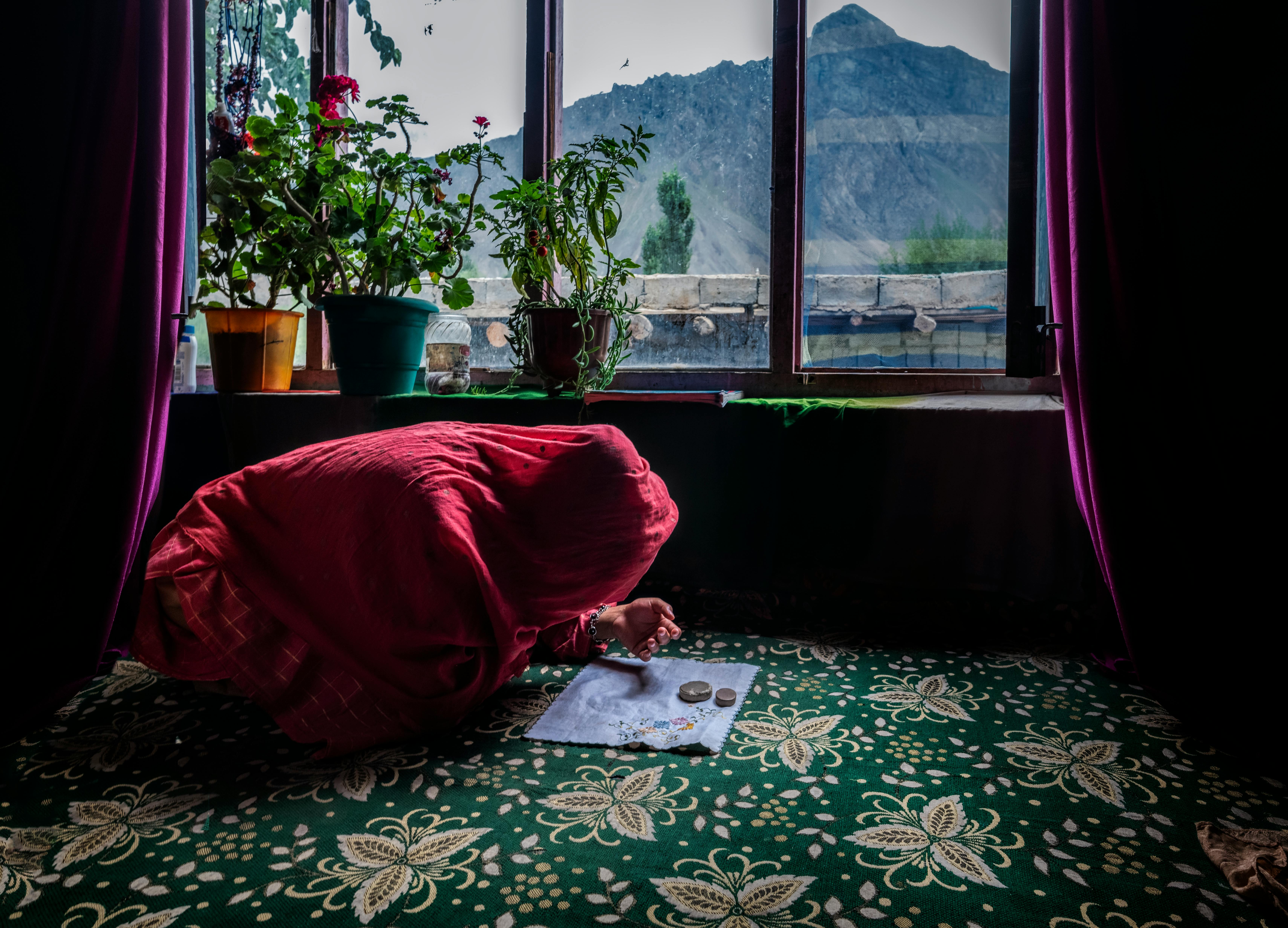 Woman in Red Headscarf kneeling beside Window · Free Stock Photo
