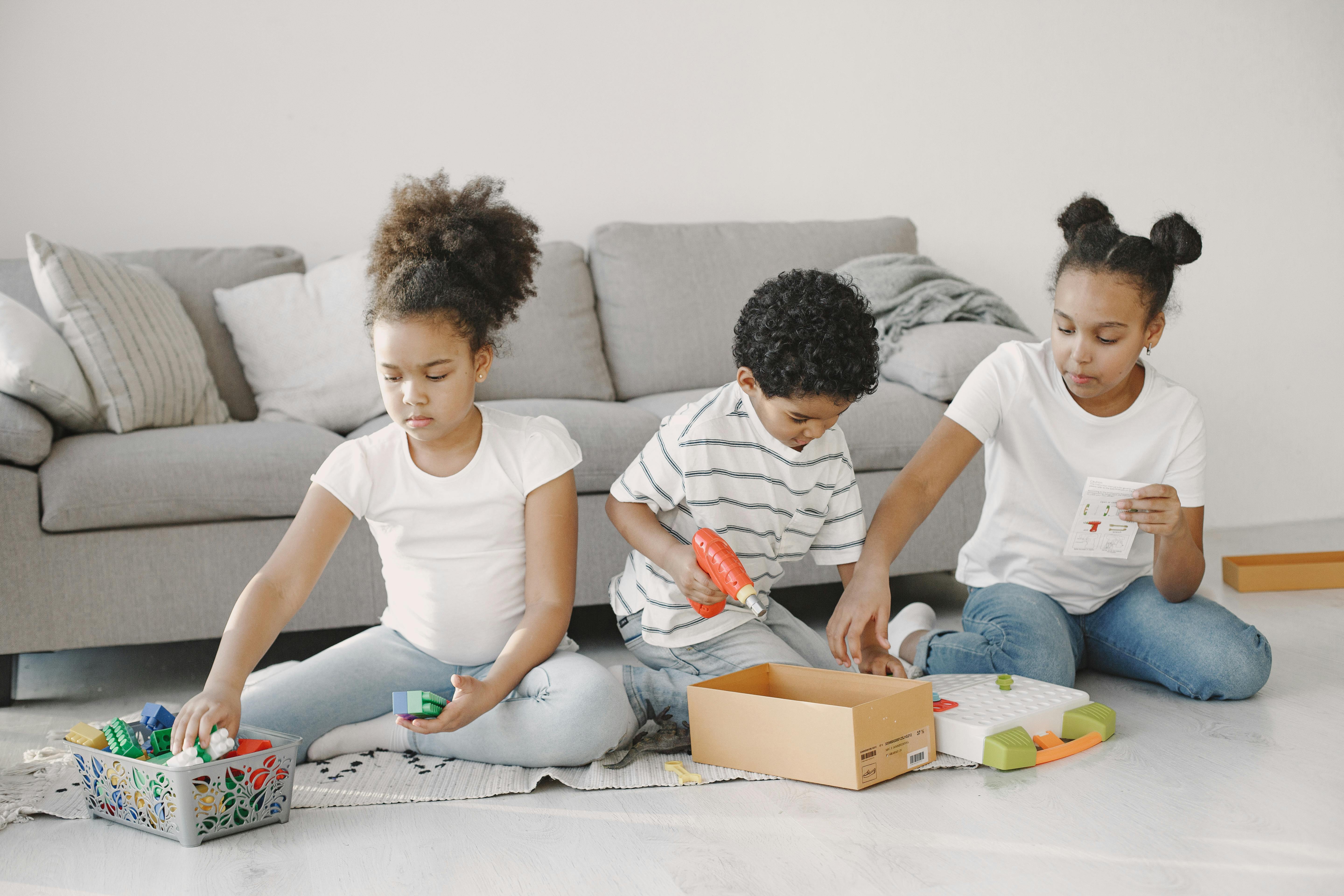 A Group of Kids Playing Toys on the Floor · Free Stock Photo