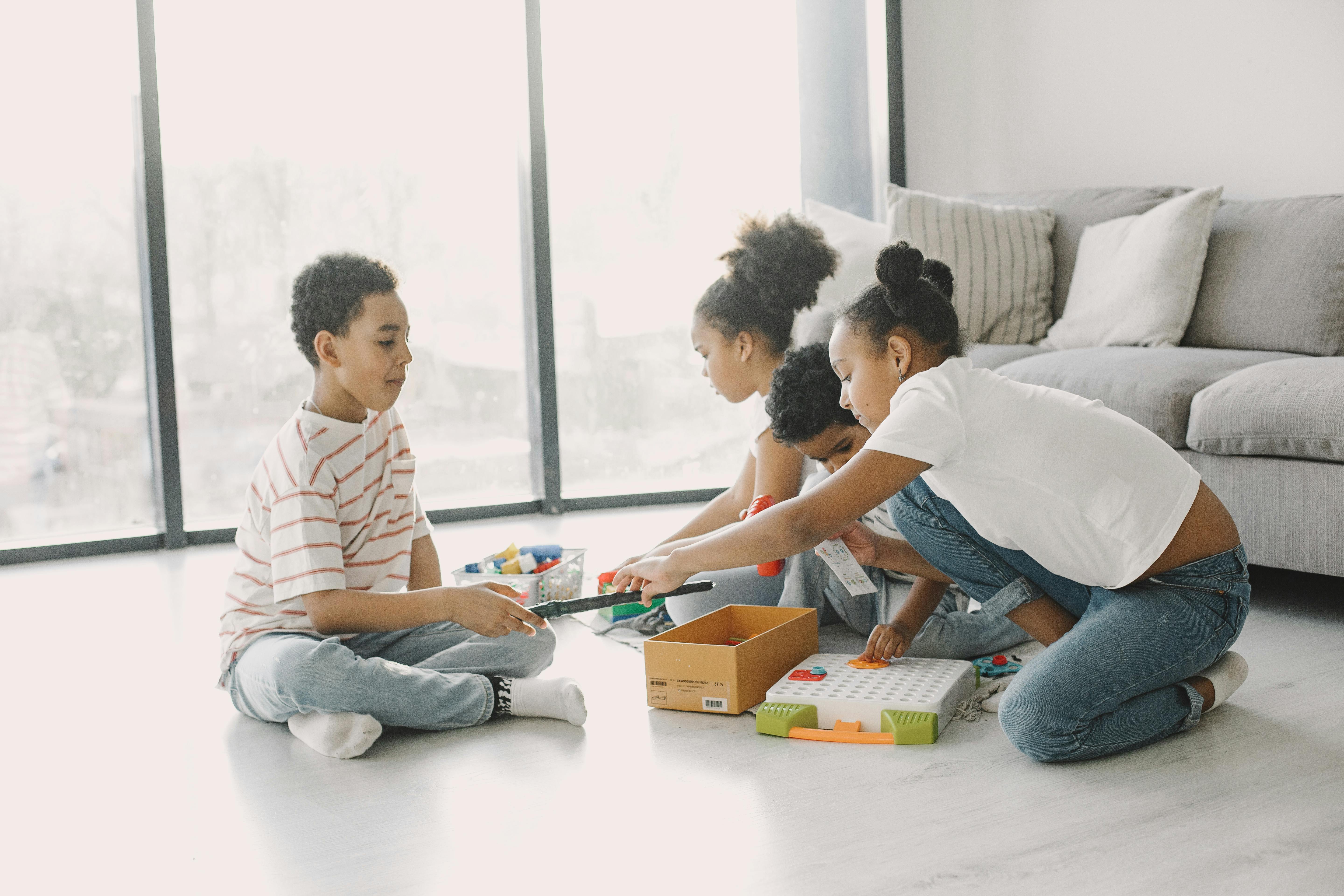 A Group of Kids Playing Toys on the Floor · Free Stock Photo