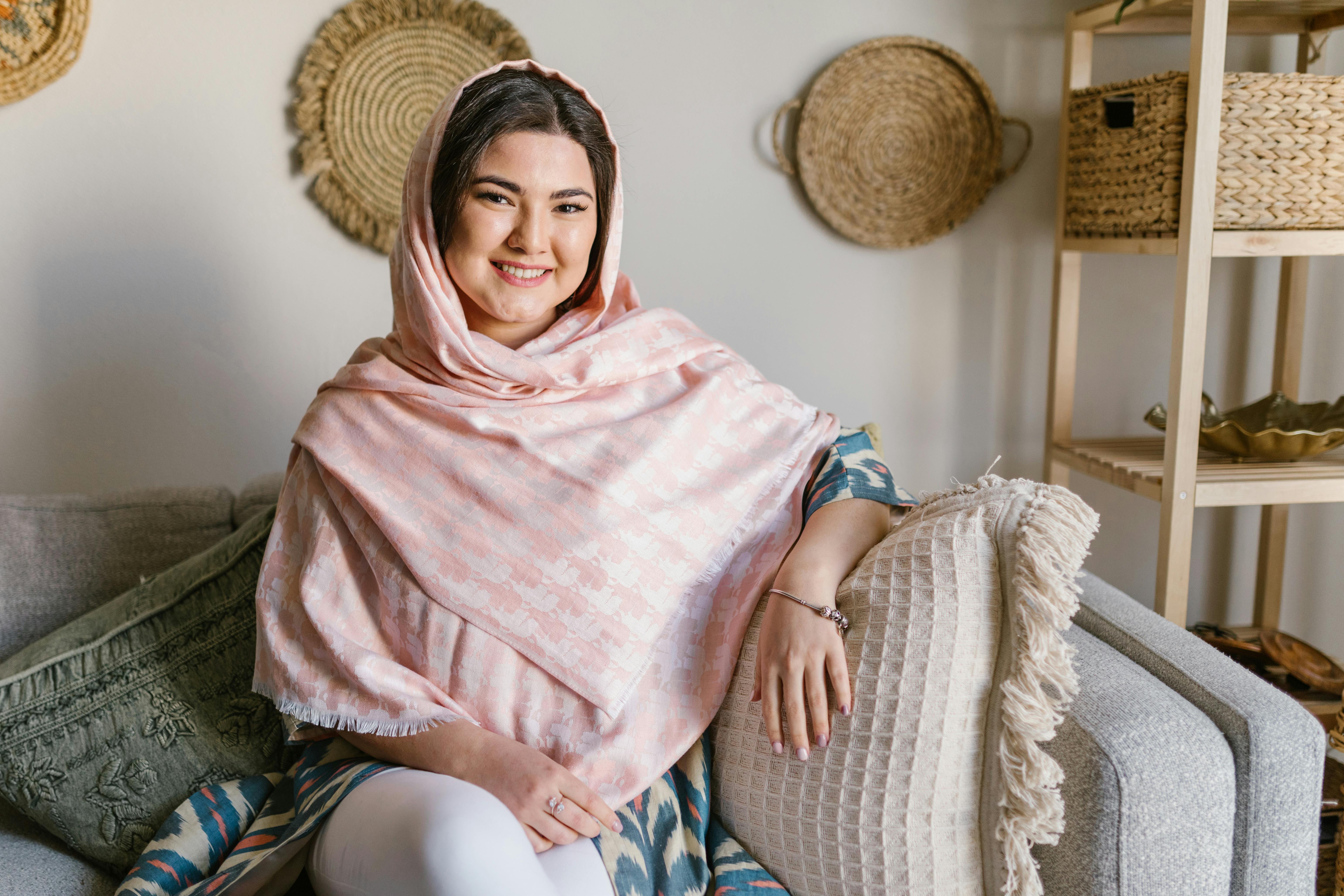 Woman in Hijab Sitting on the Sofa · Free Stock Photo