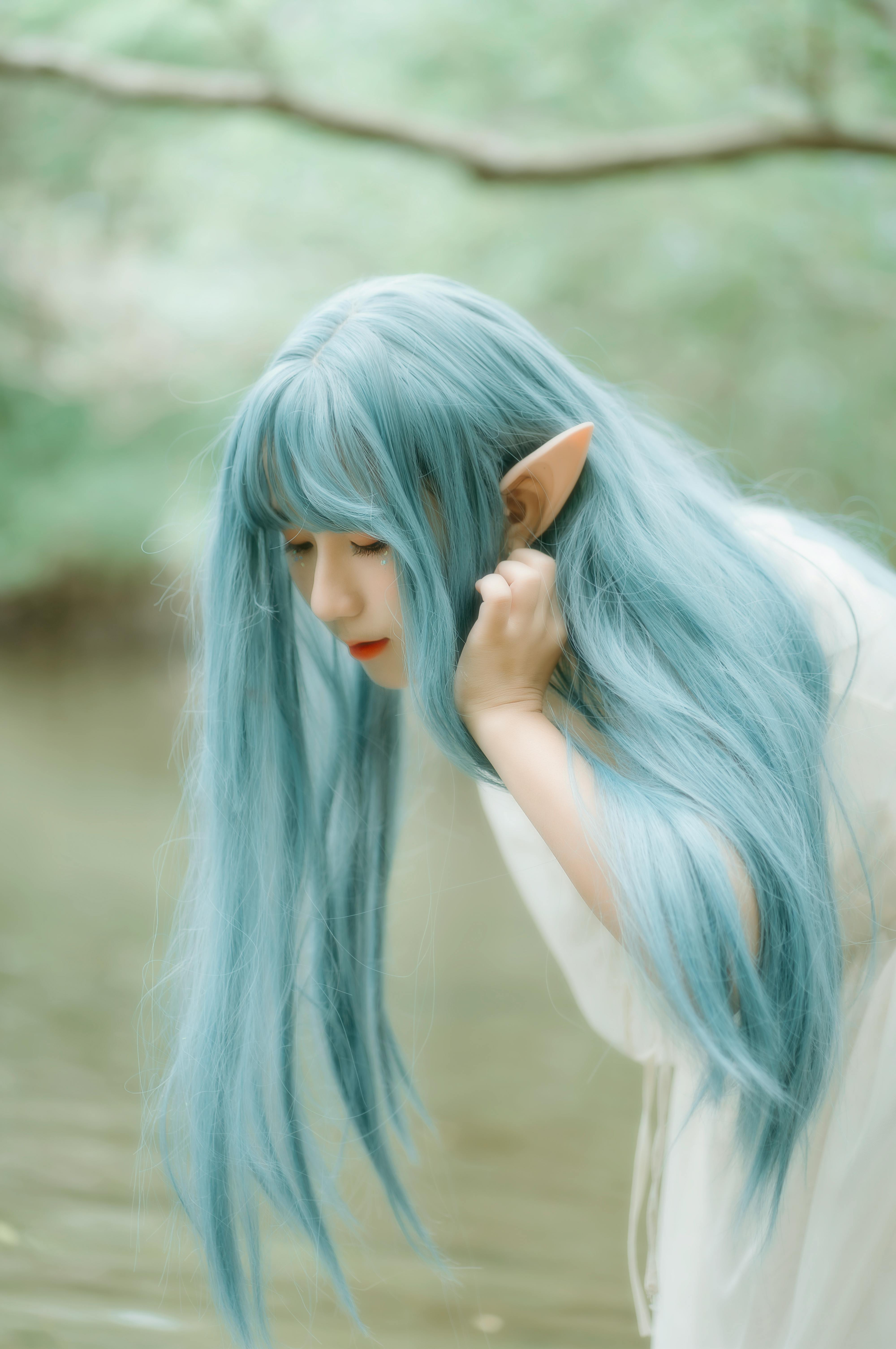 An Elf Peeking in Between Tree Trunks · Free Stock Photo