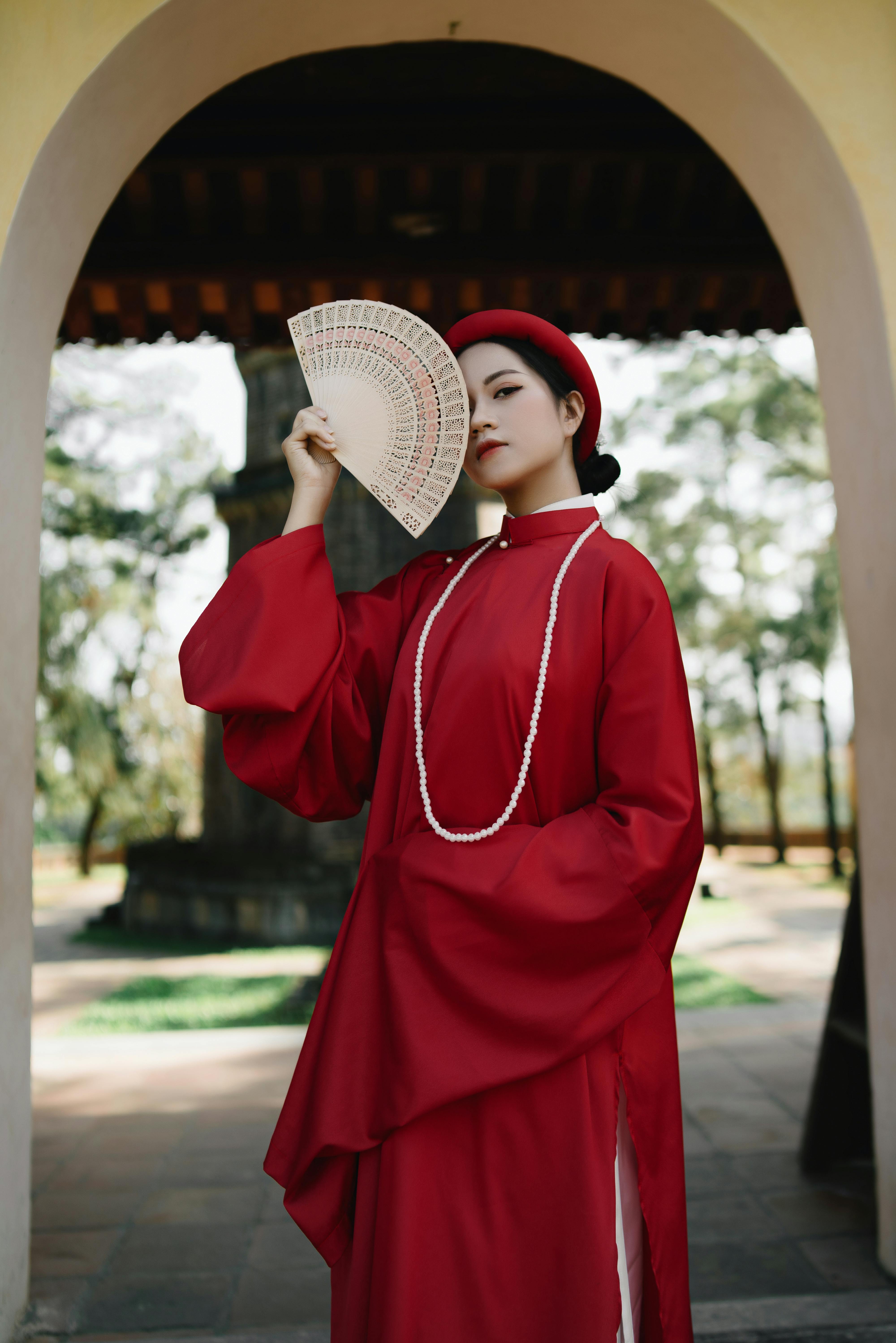Model in Traditional Clothing Holding Fan · Free Stock Photo