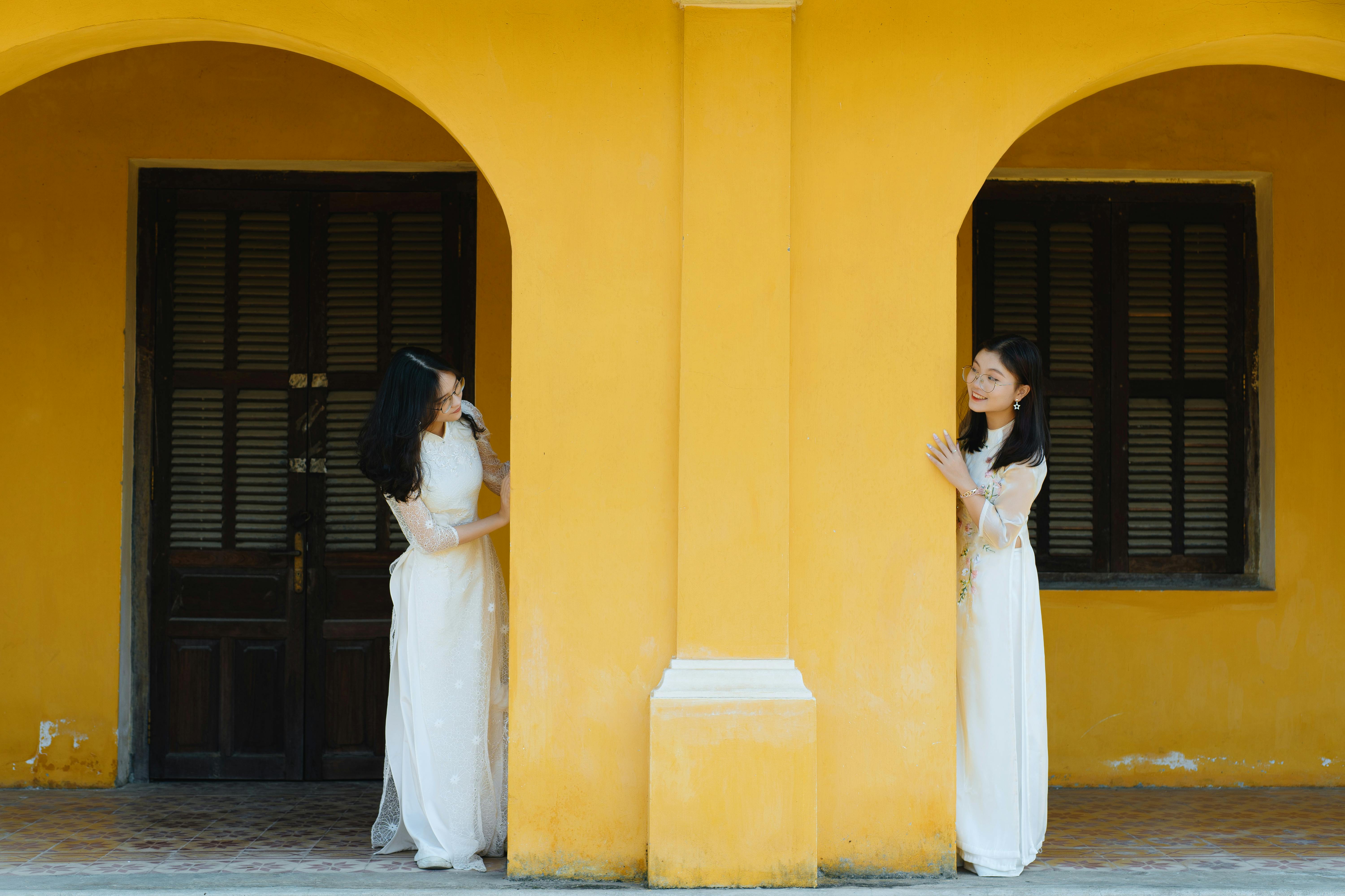 Women in White and Pink Dress Standing on the Veranda · Free Stock Photo