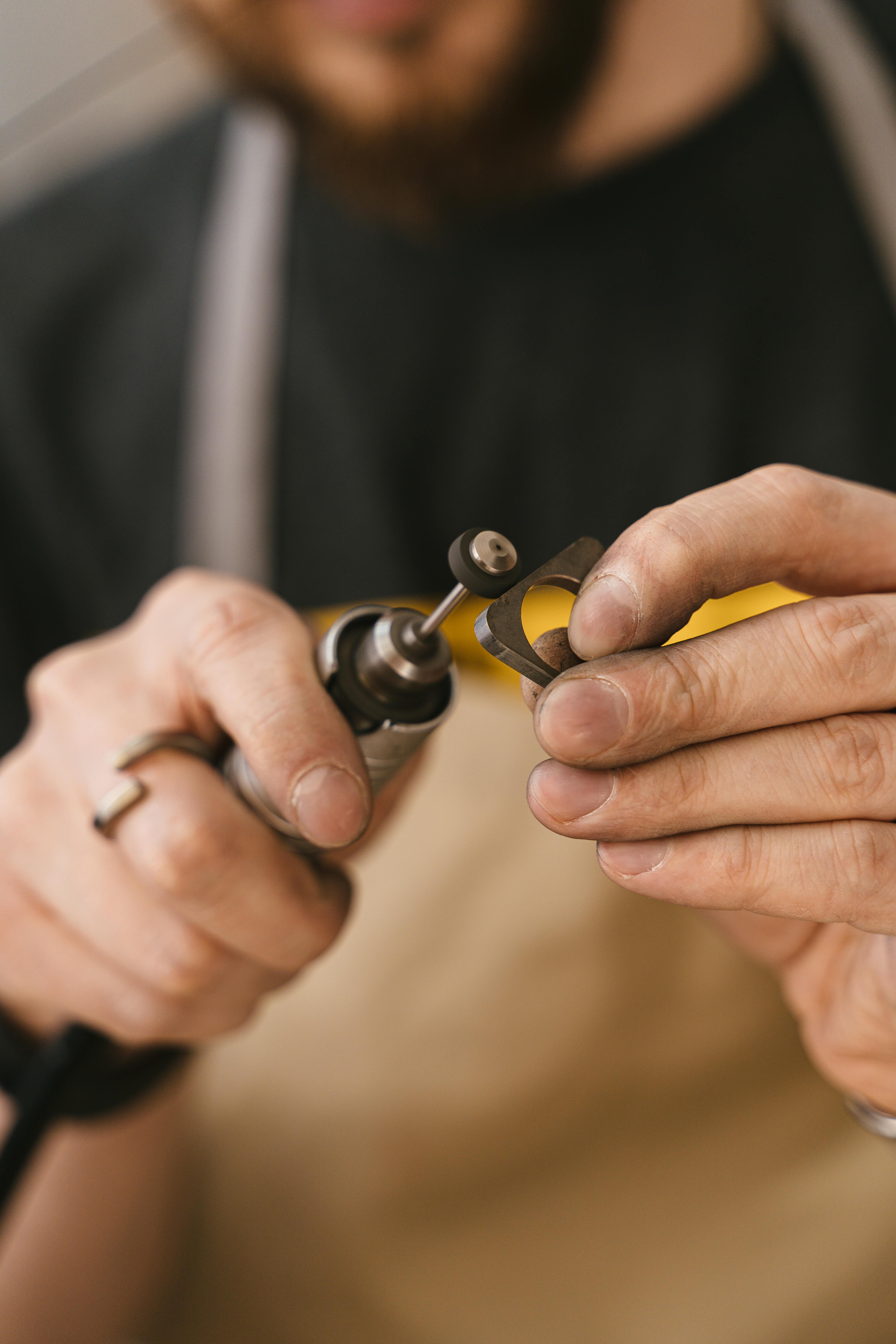 Person Holding Black and Silver Hand Tool · Free Stock Photo
