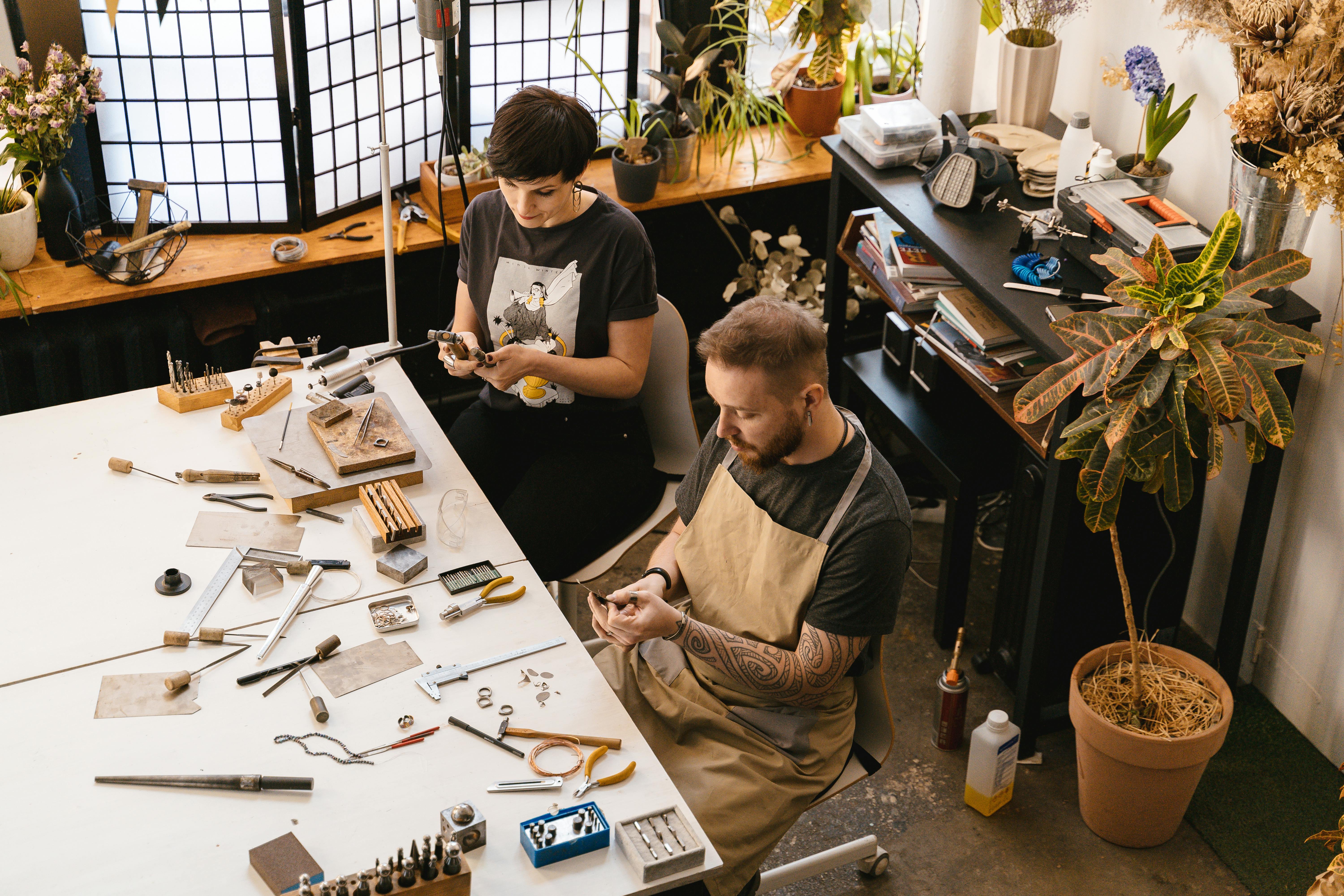 Man and Woman Working in a Workshop · Free Stock Photo