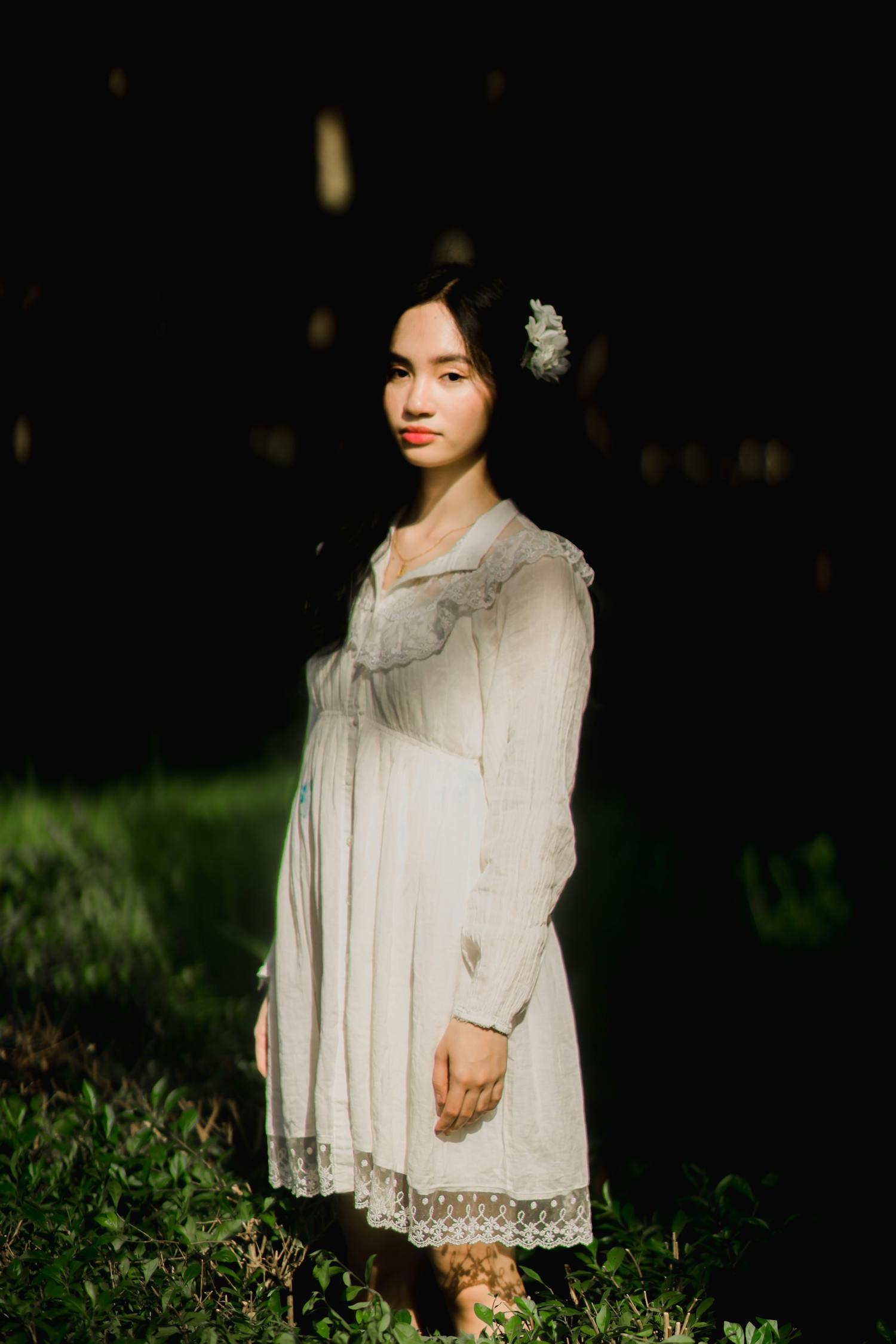 Woman In White Long Sleeve Dress Standing On Green Grass Field · Free