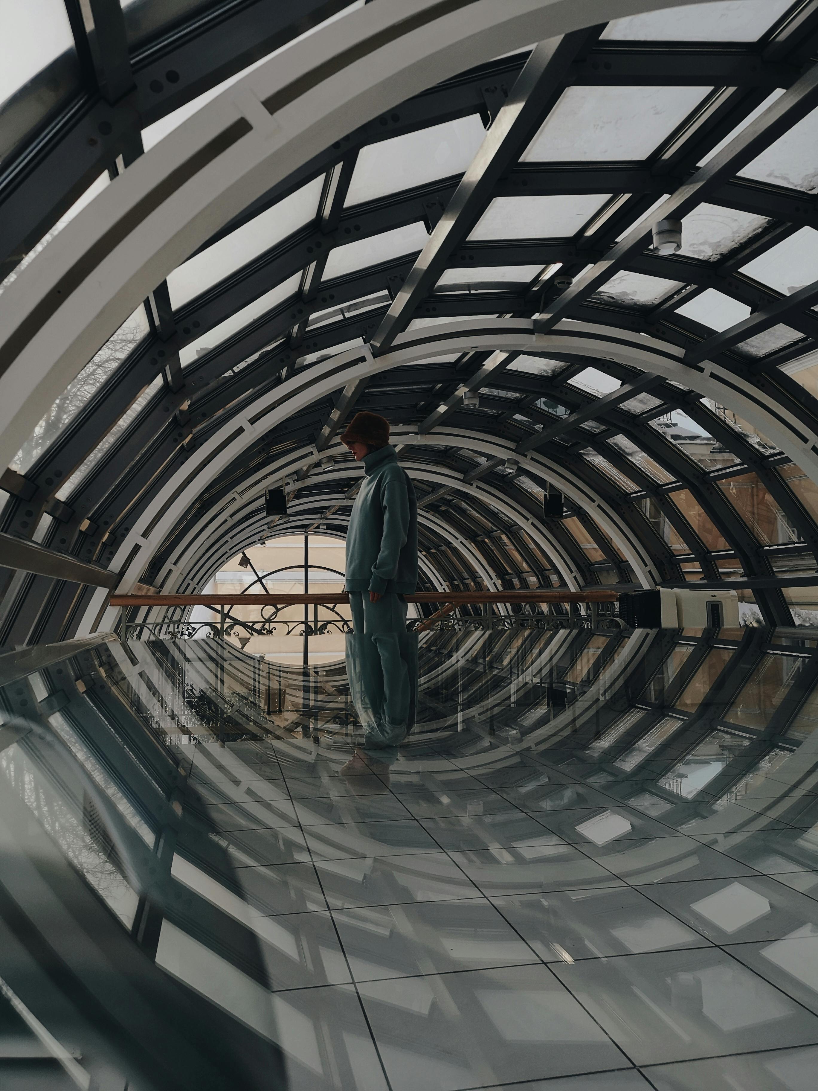 Man standing in room with glass walls and ceiling · Free Stock Photo