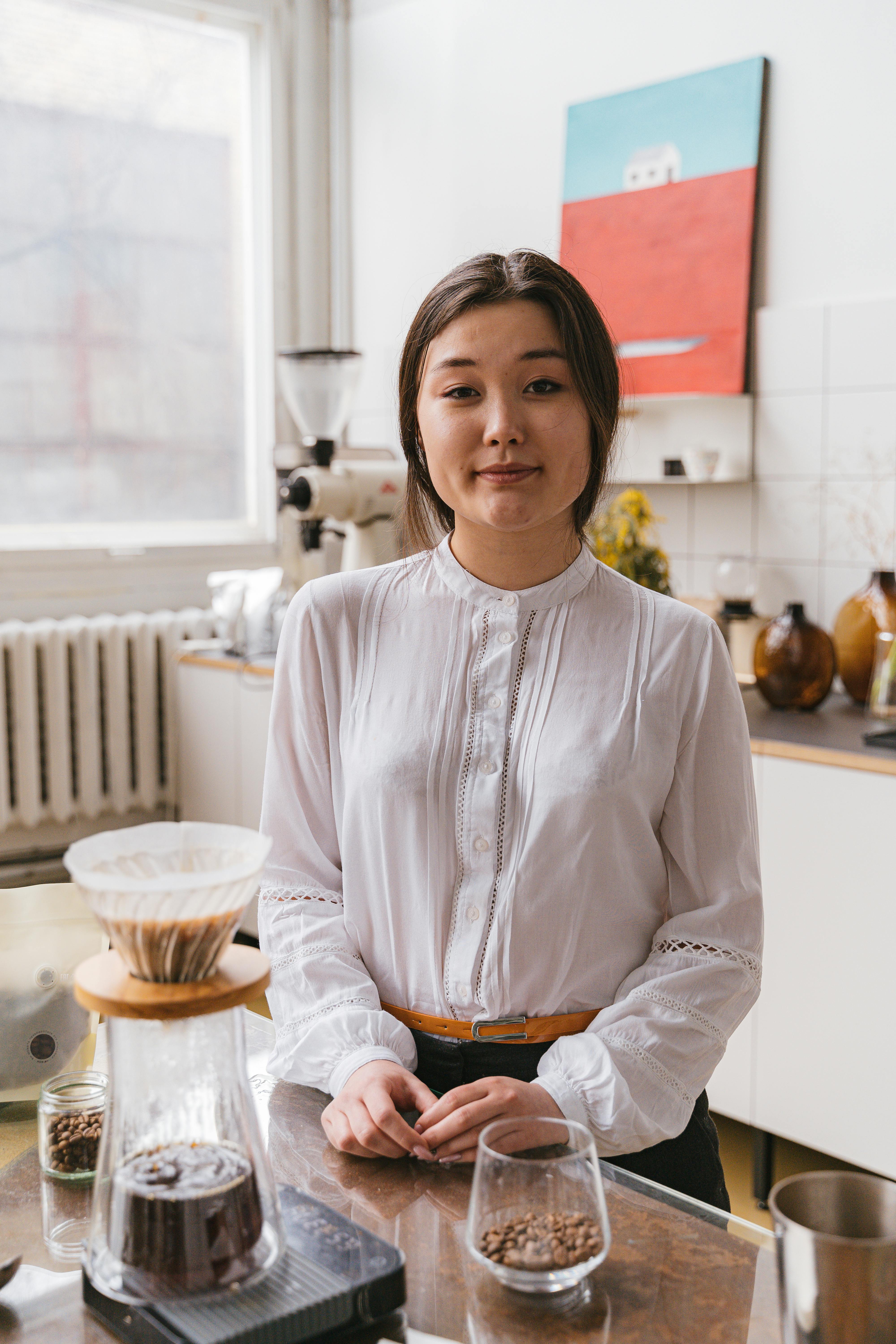 Woman in White Long Sleeves Standing Beside a Coffee Dripper · Free ...