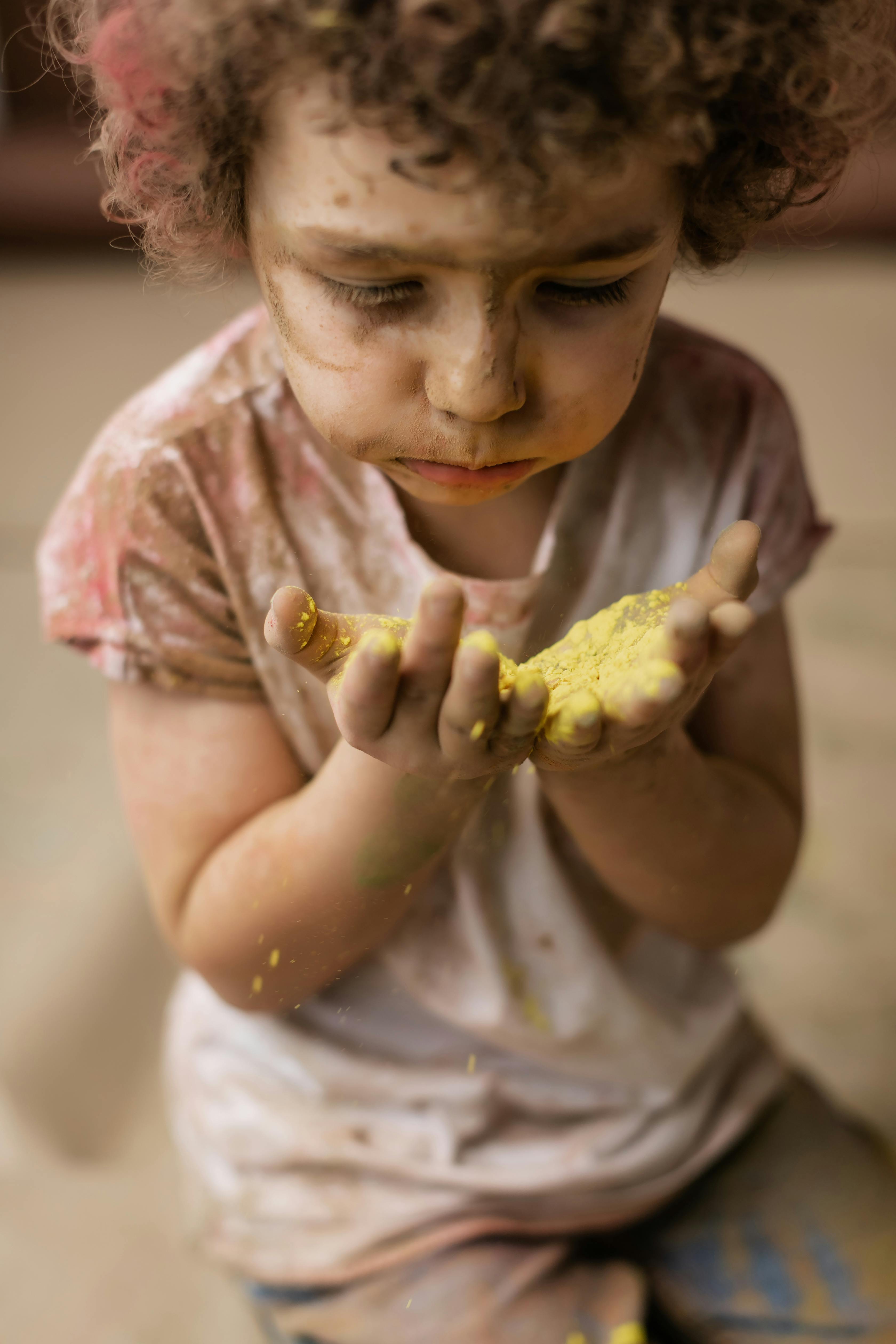 Little Boy Holding Yellow Powder · Free Stock Photo