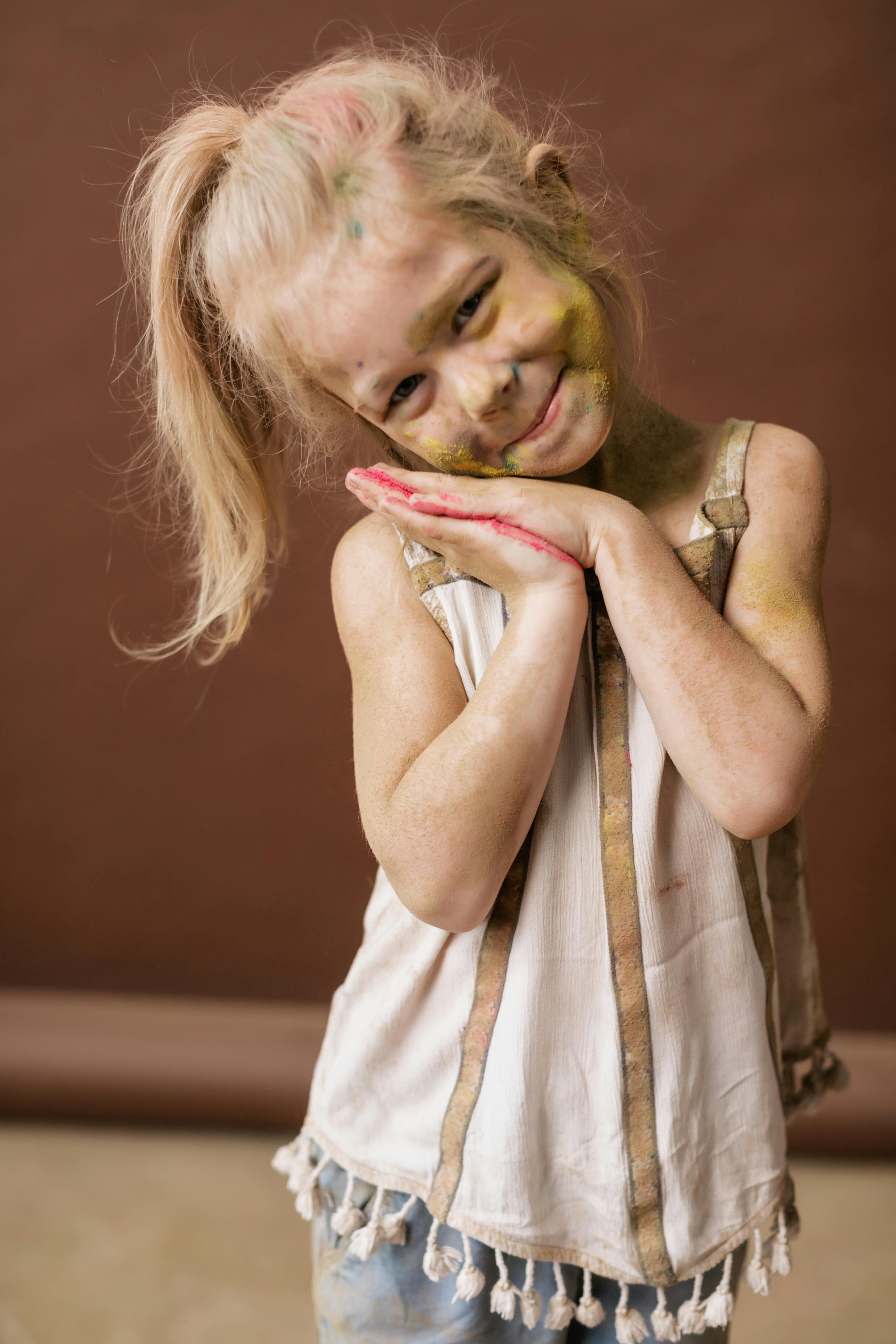 Cute Little Girl with Colored Powder on Face · Free Stock Photo