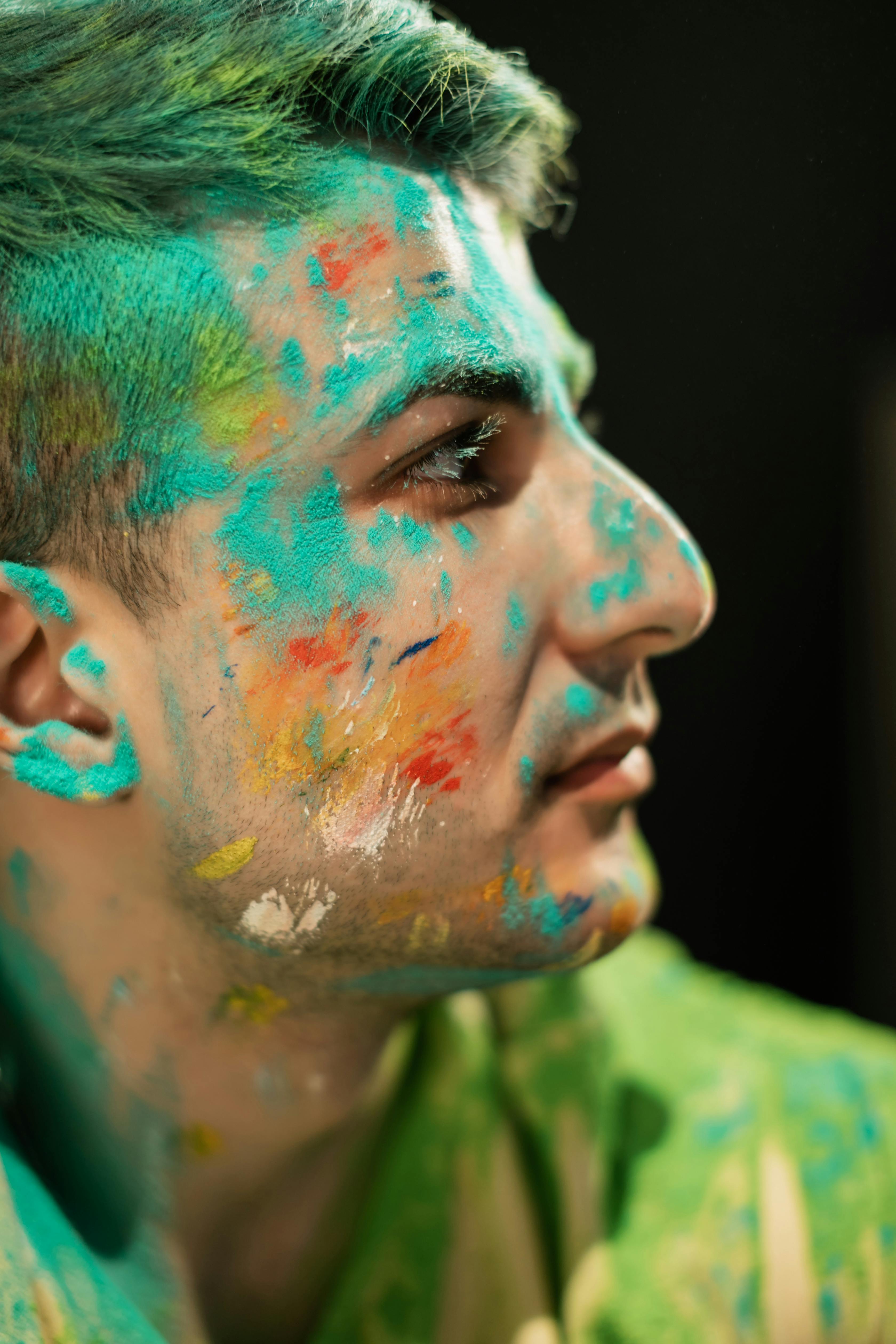 Close-Up Shot of a Man with Colored Face Powder · Free Stock Photo