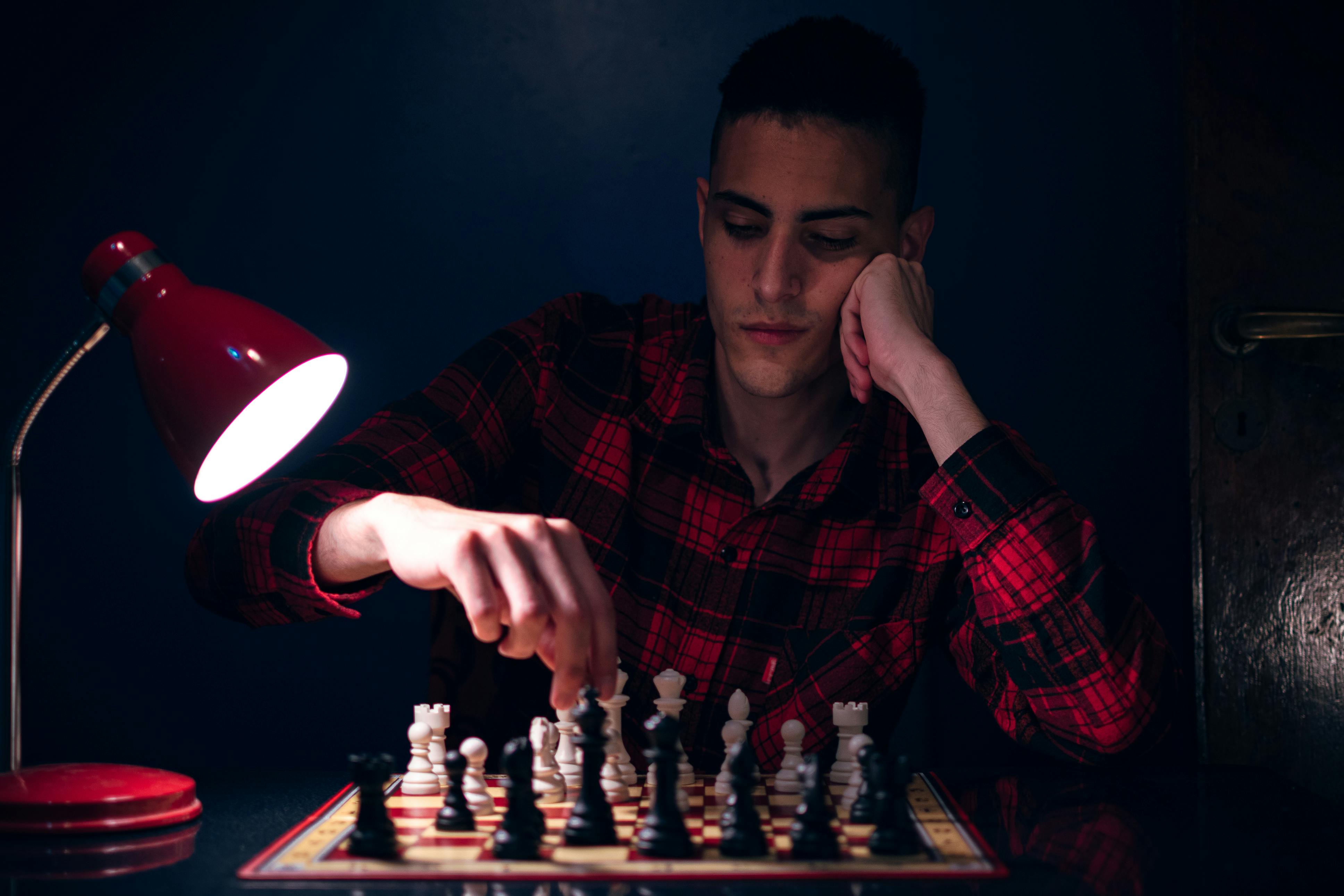 Man in Red and Black Plaid Dress Shirt Holding Chess Piece · Free Stock ...