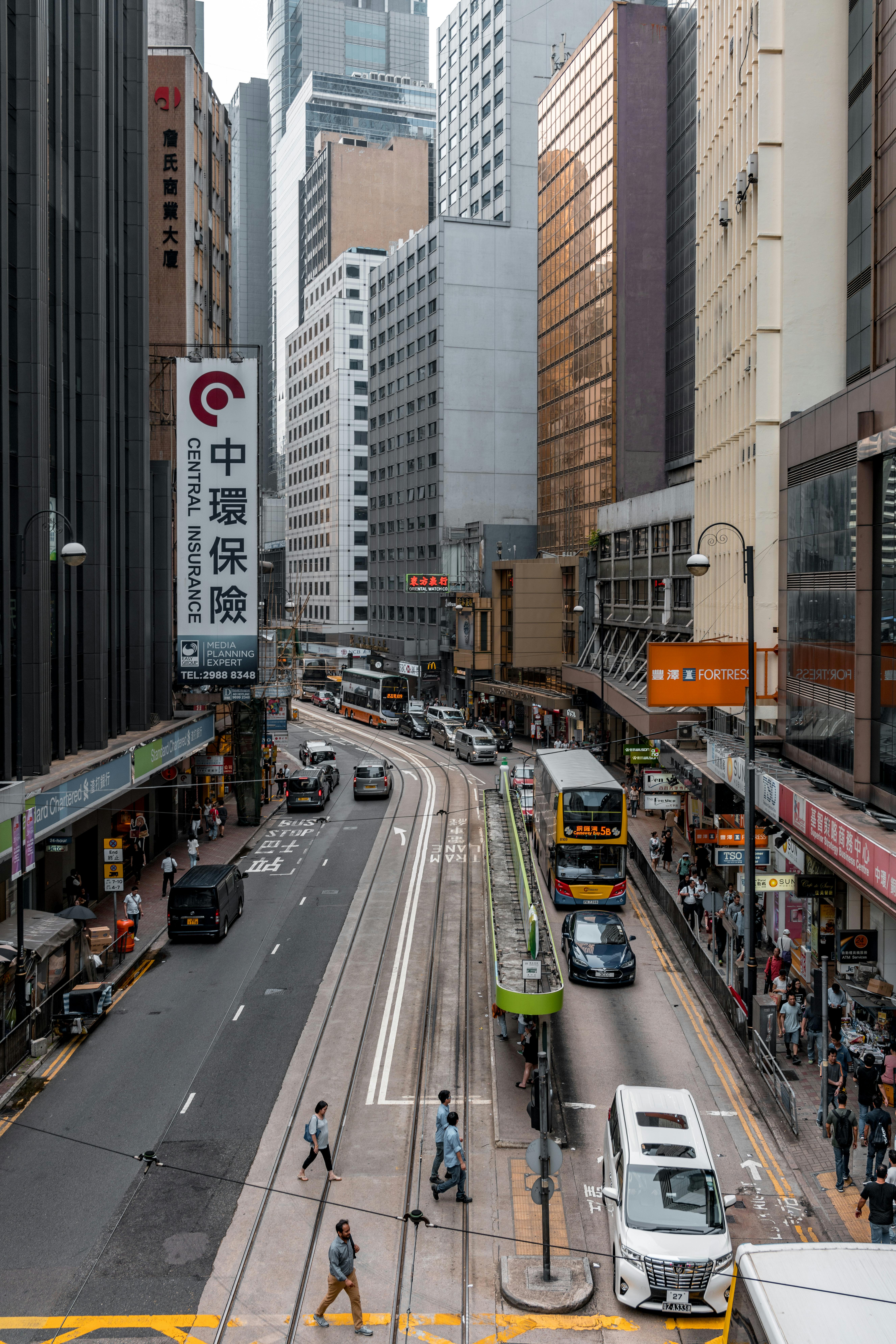 A High Angle Shot of a Busy Downtown with People and Vehicles on the ...