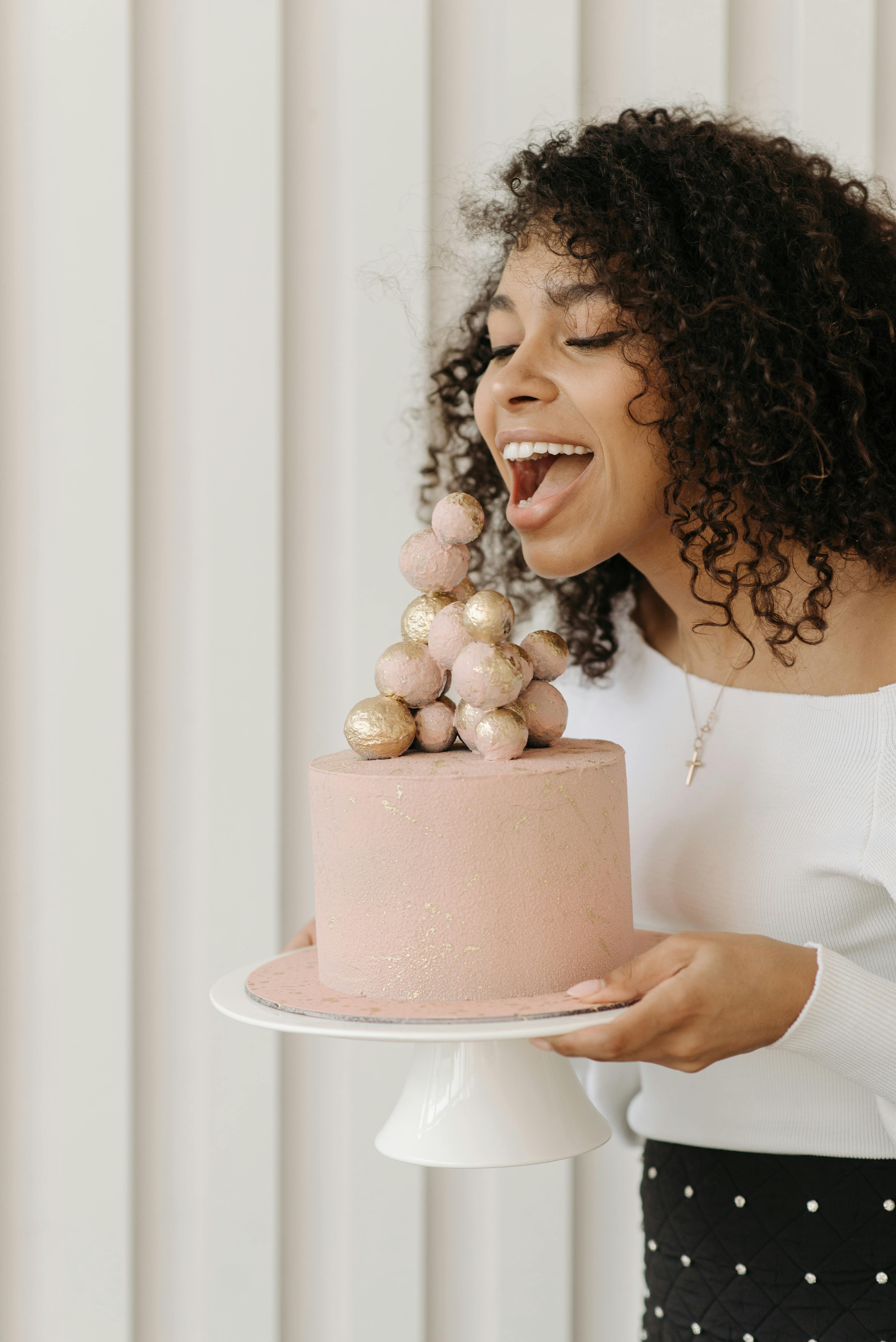 A Woman Holding a Cake · Free Stock Photo