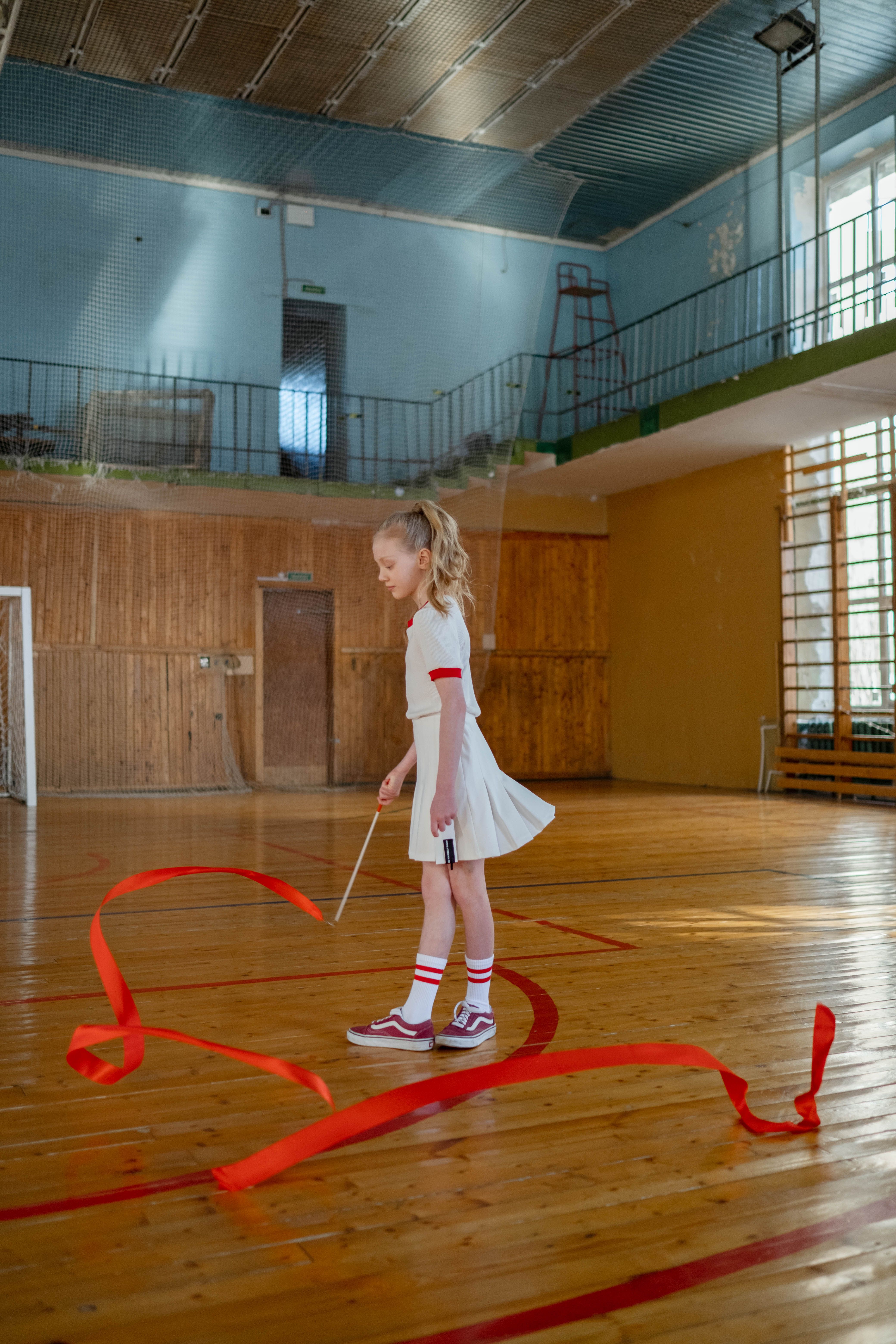 Girl in Orange Sports Wear Doing Hula Hoop · Free Stock Photo