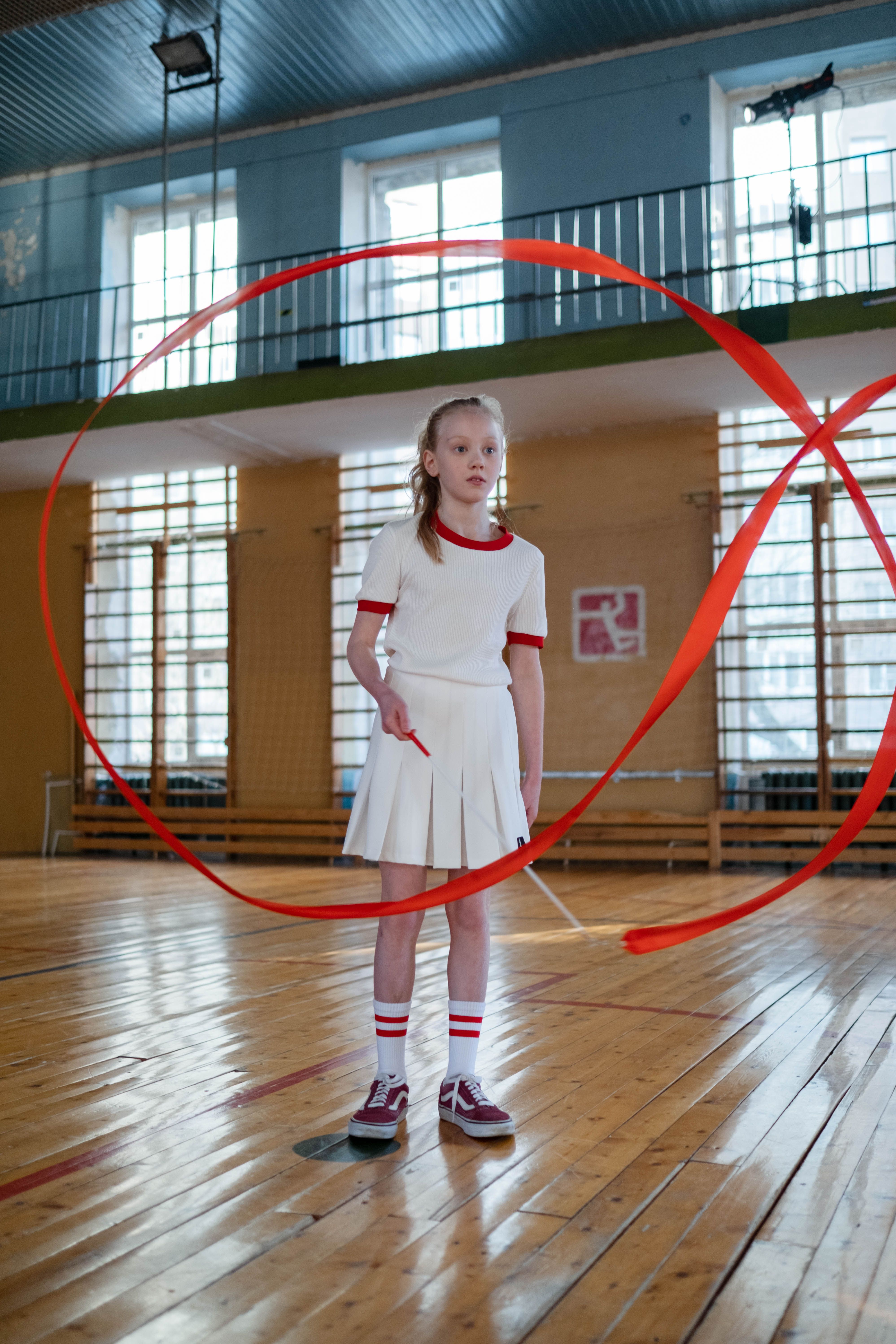 Girl in Orange Sports Wear Doing Hula Hoop · Free Stock Photo