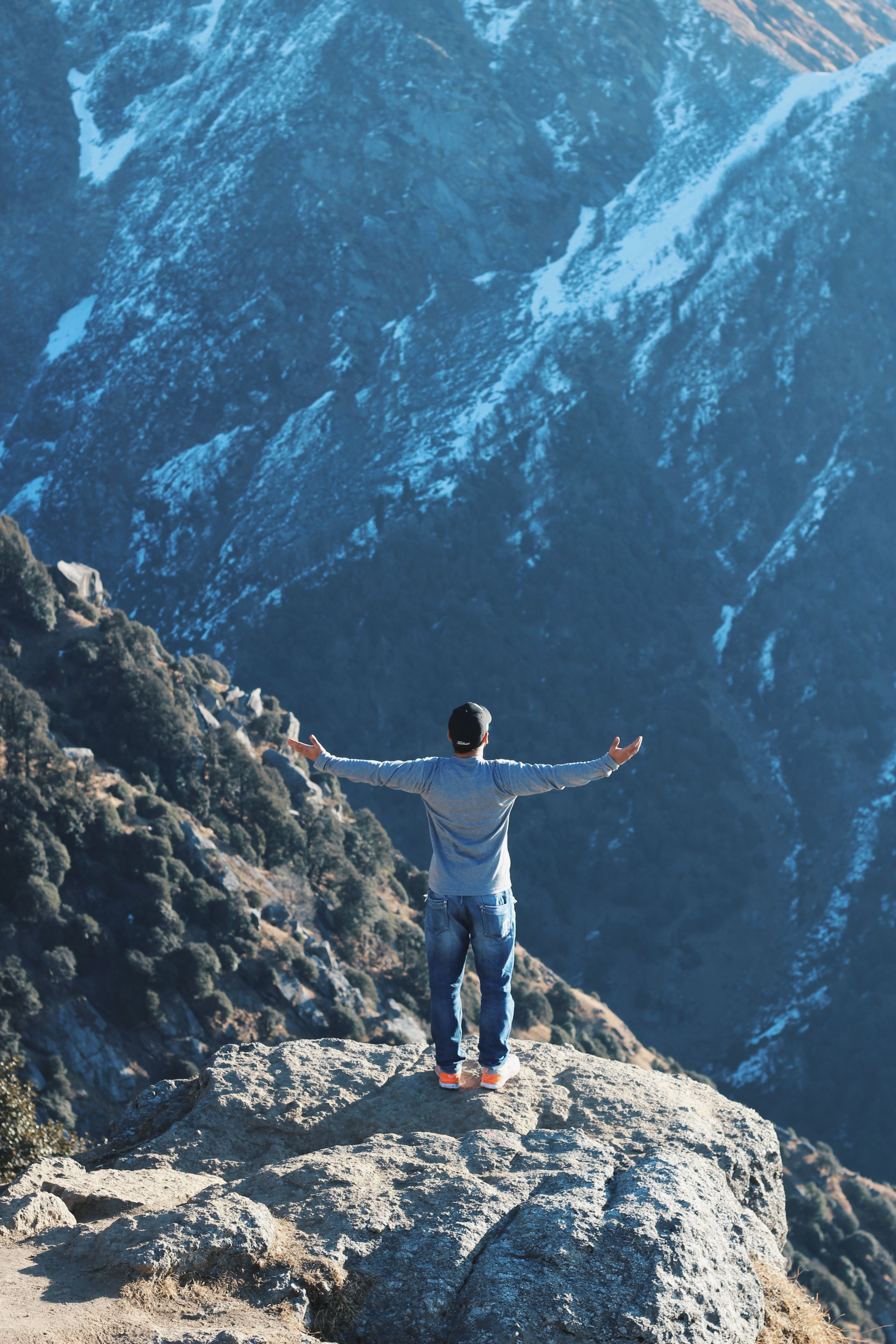A Man Standing on Top of a Mountain · Free Stock Photo