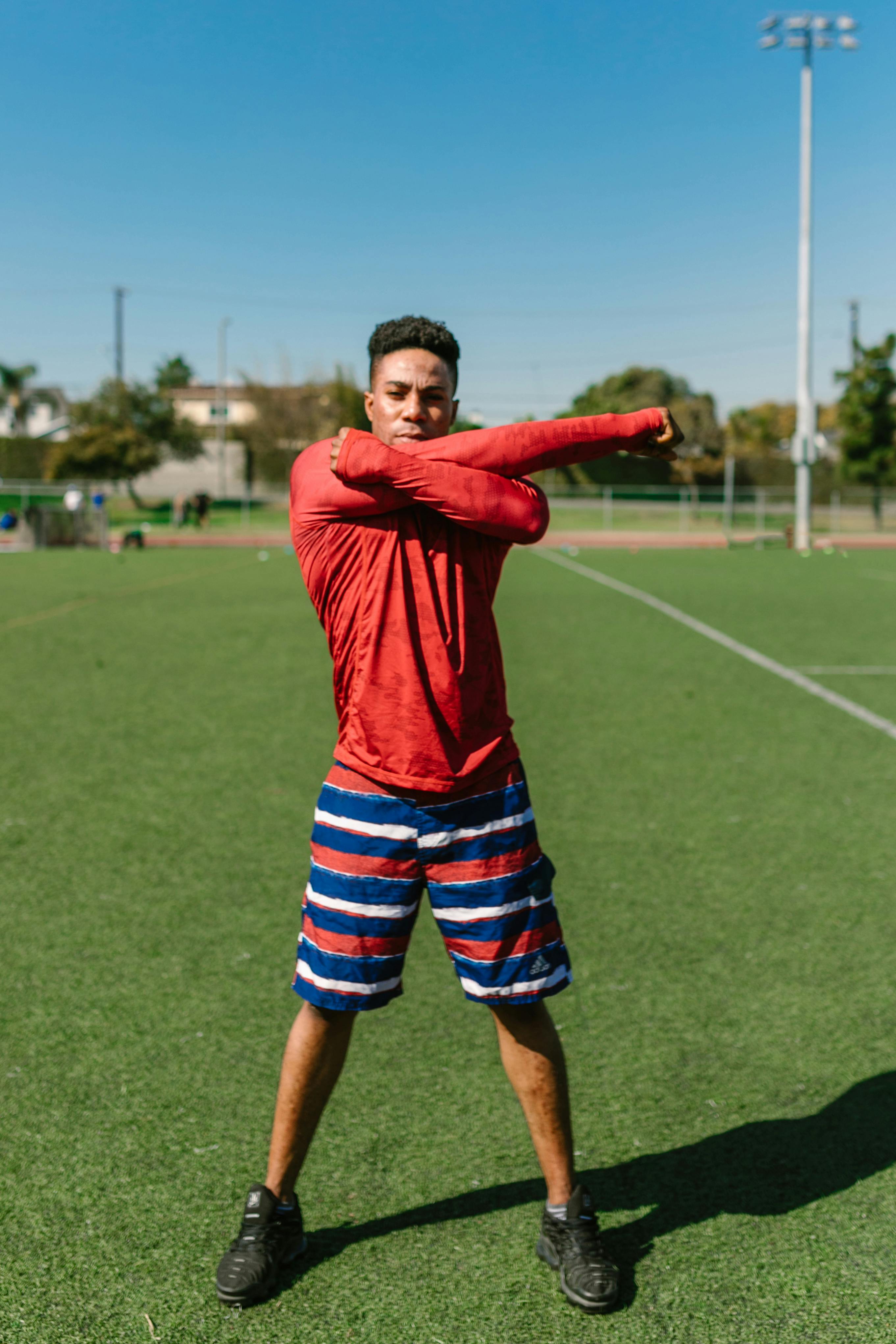 Man Playing Football in a School Gymnasium · Free Stock Photo