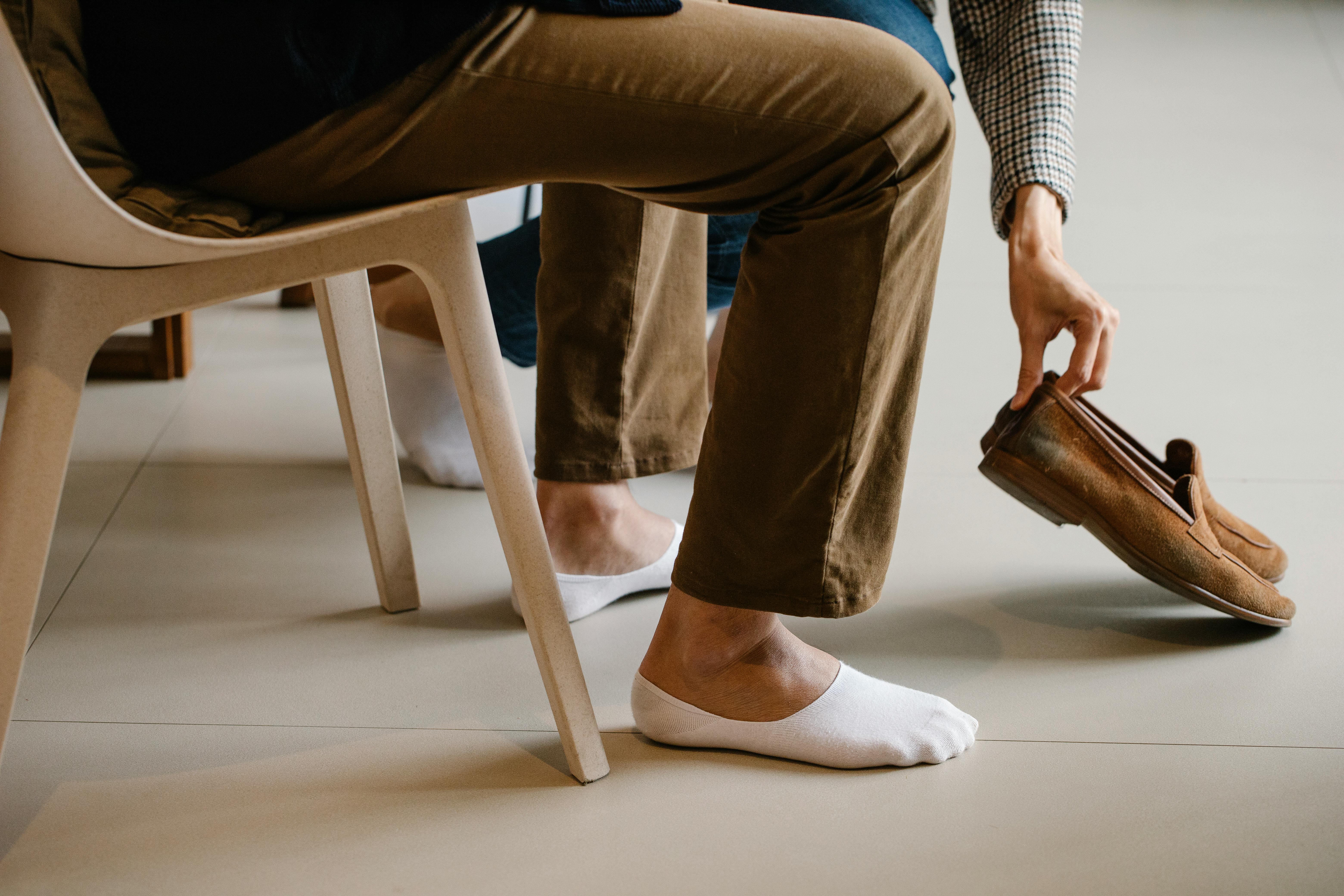 Photo of Person Holding his Shoes · Free Stock Photo