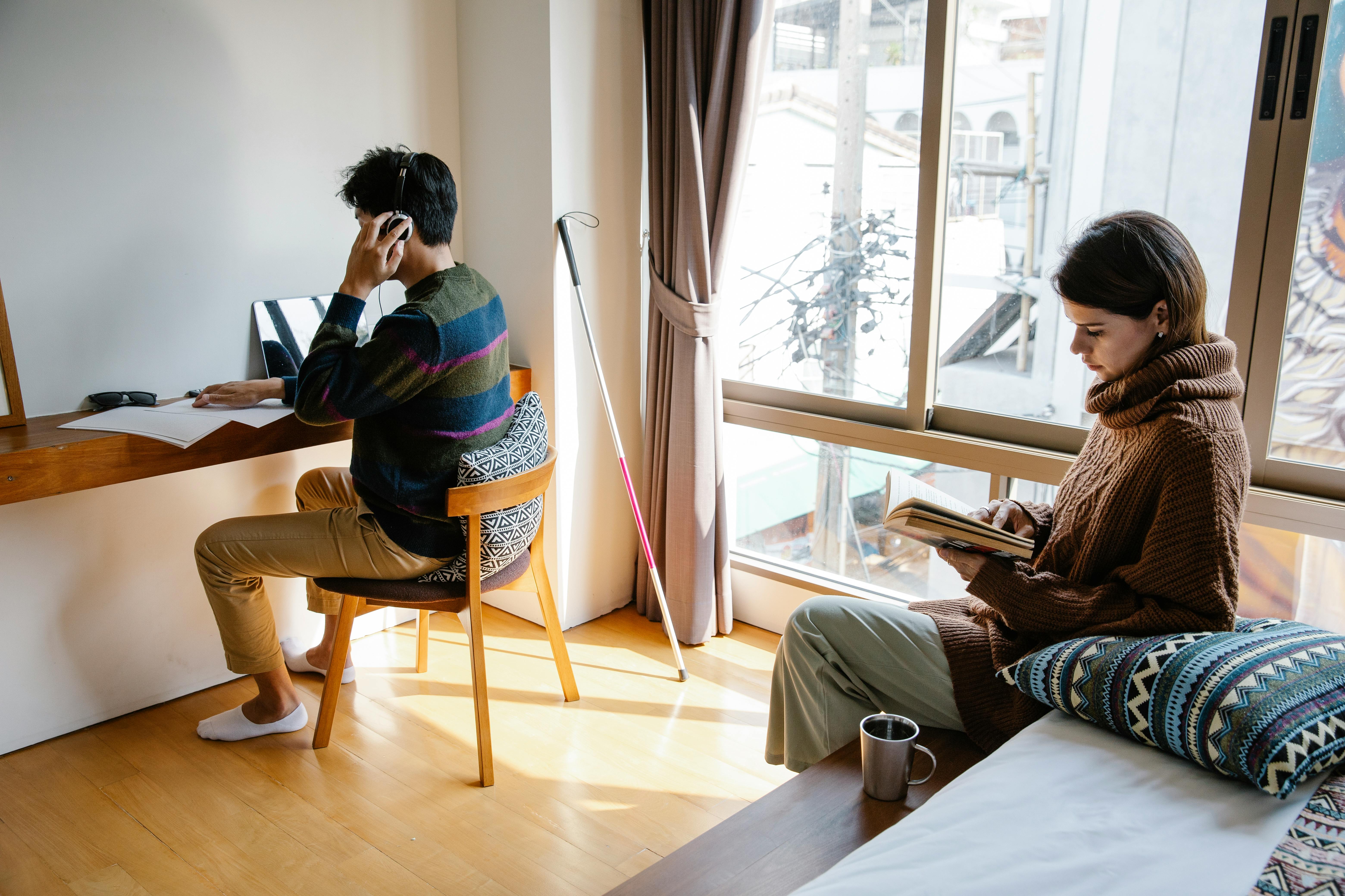 Photo of Woman Reading Book Beside Window · Free Stock Photo