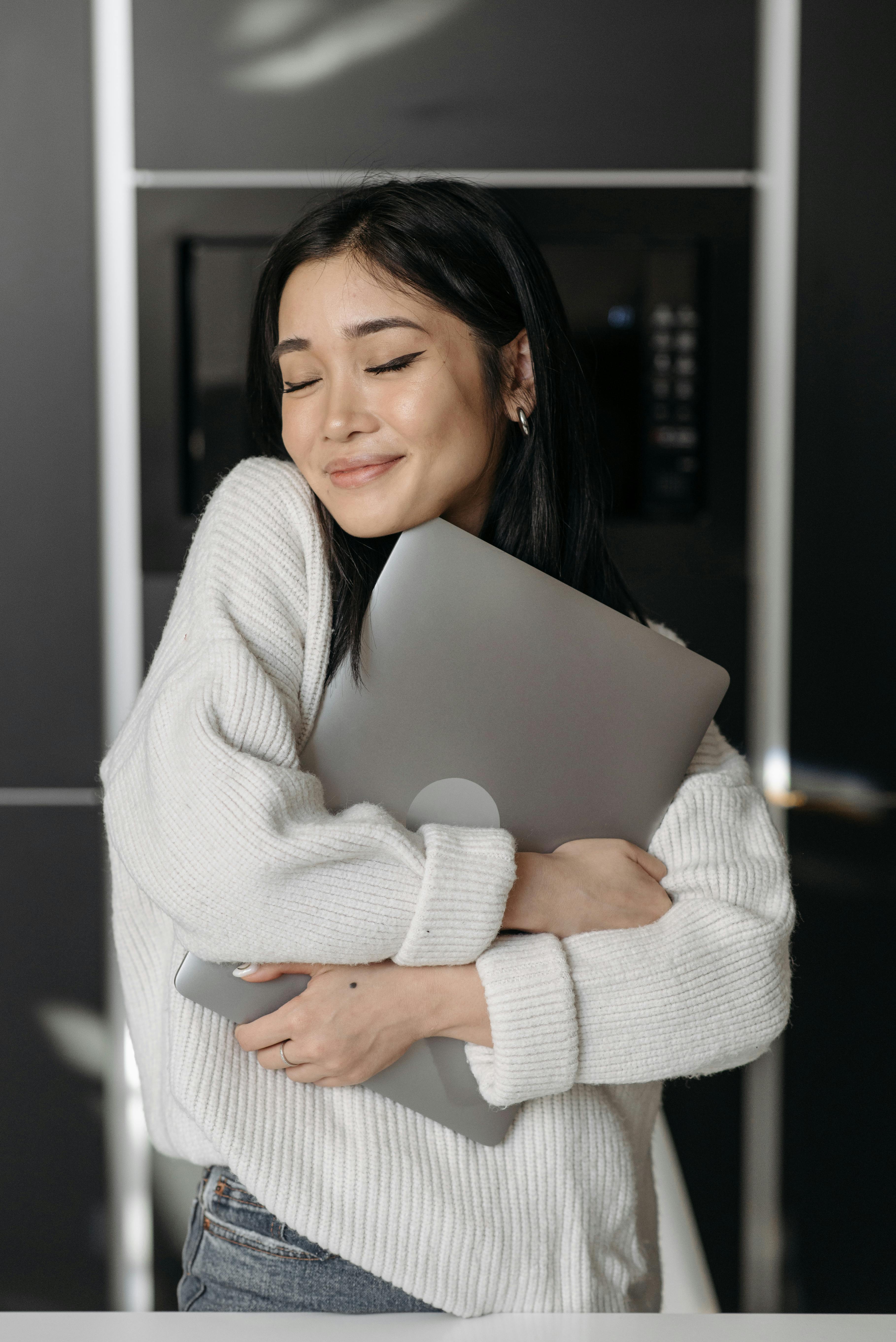 Woman Smiling while Hugging the Laptop · Free Stock Photo