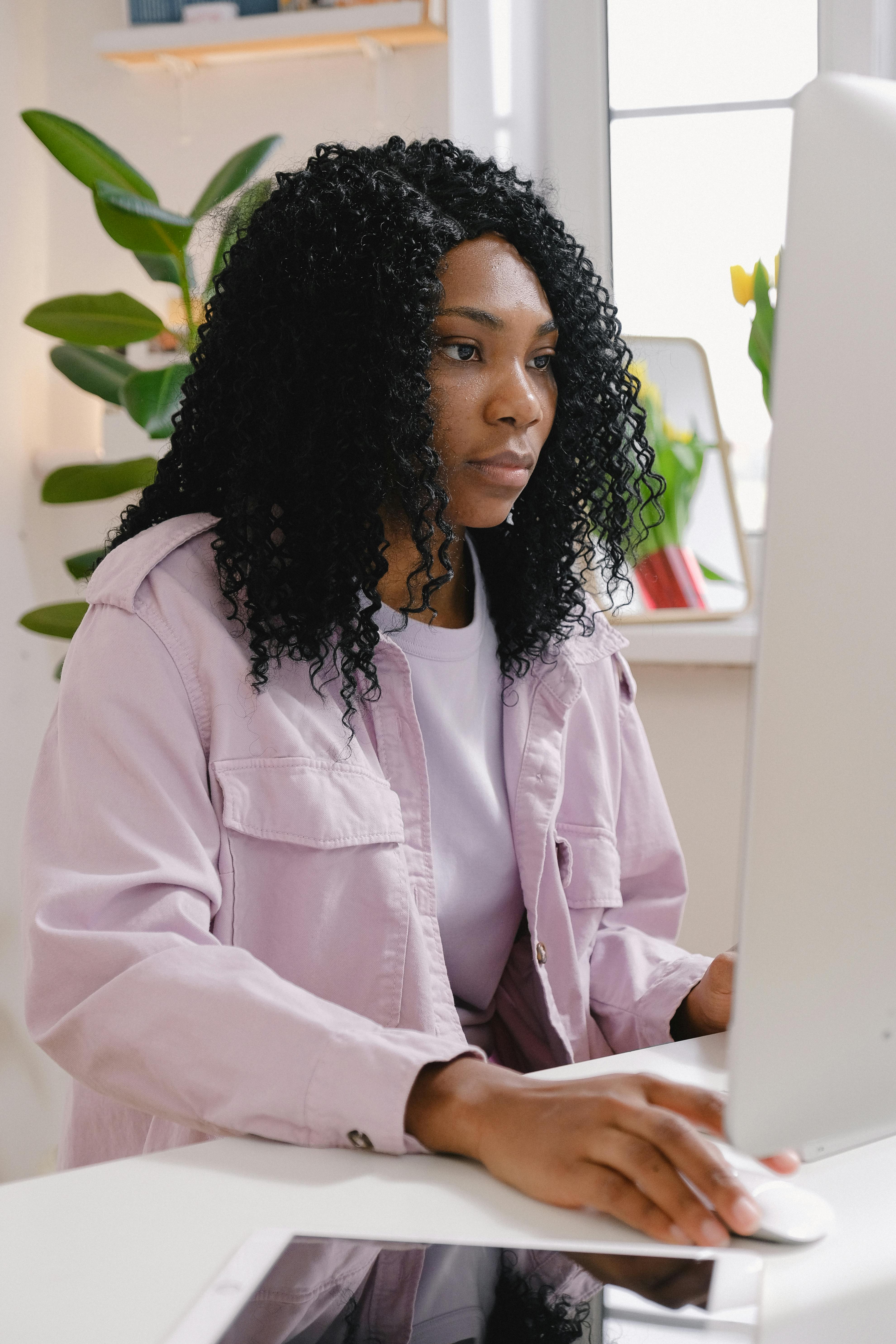 Focused woman working on laptop · Free Stock Photo