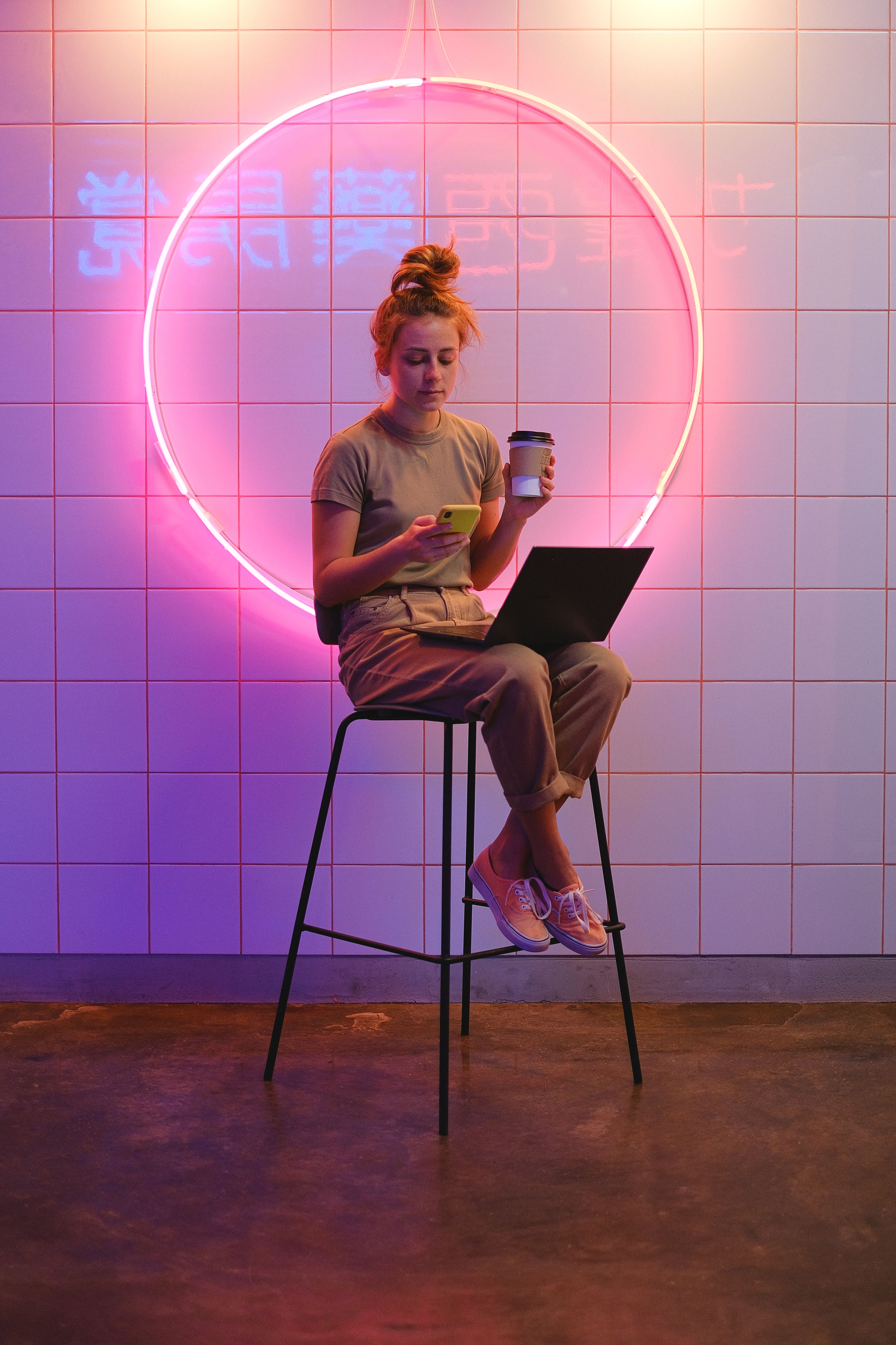 Woman in Brown Shirt Sitting on Chair Texting · Free Stock Photo